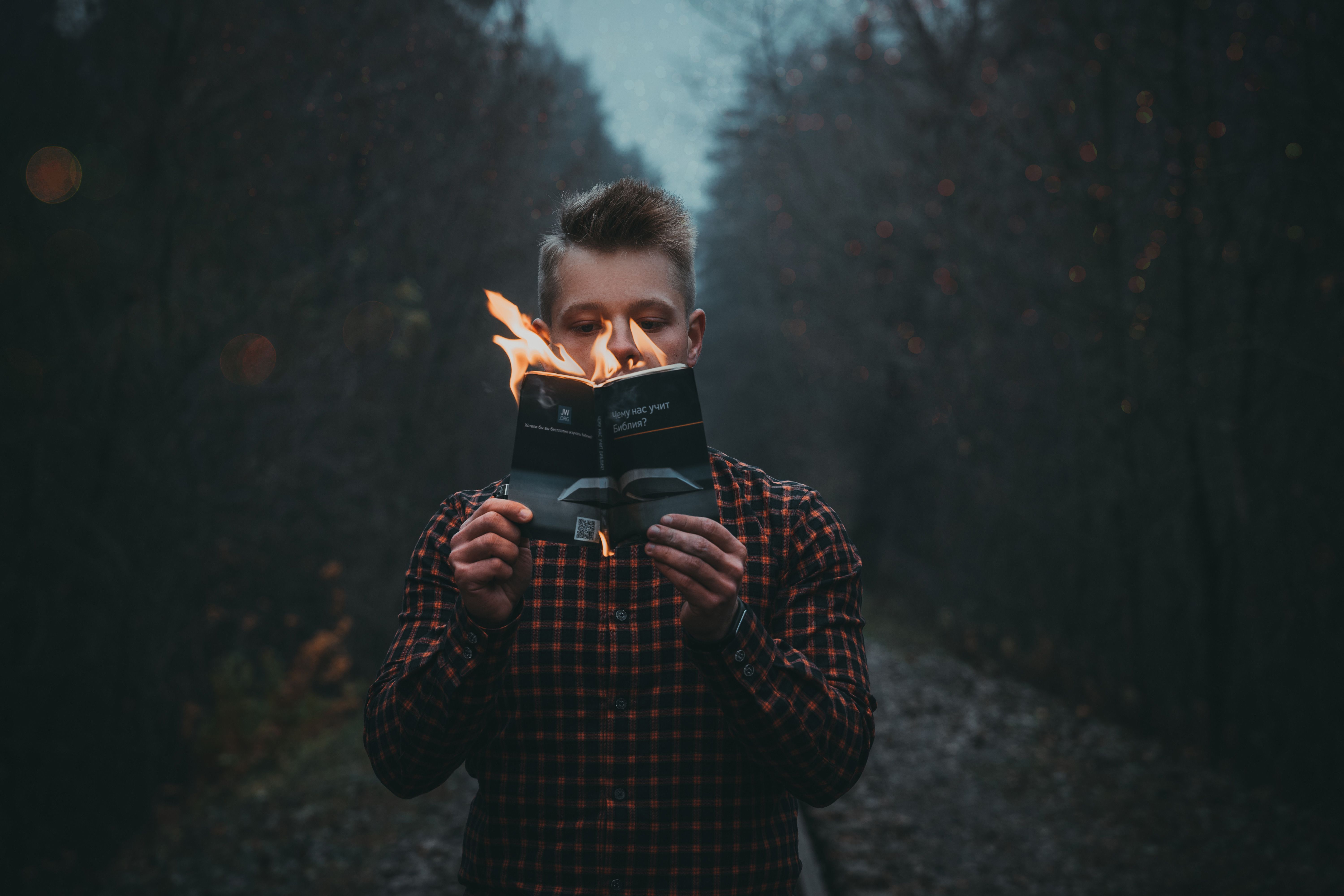 Man with Book in Flames · Free Stock Photo