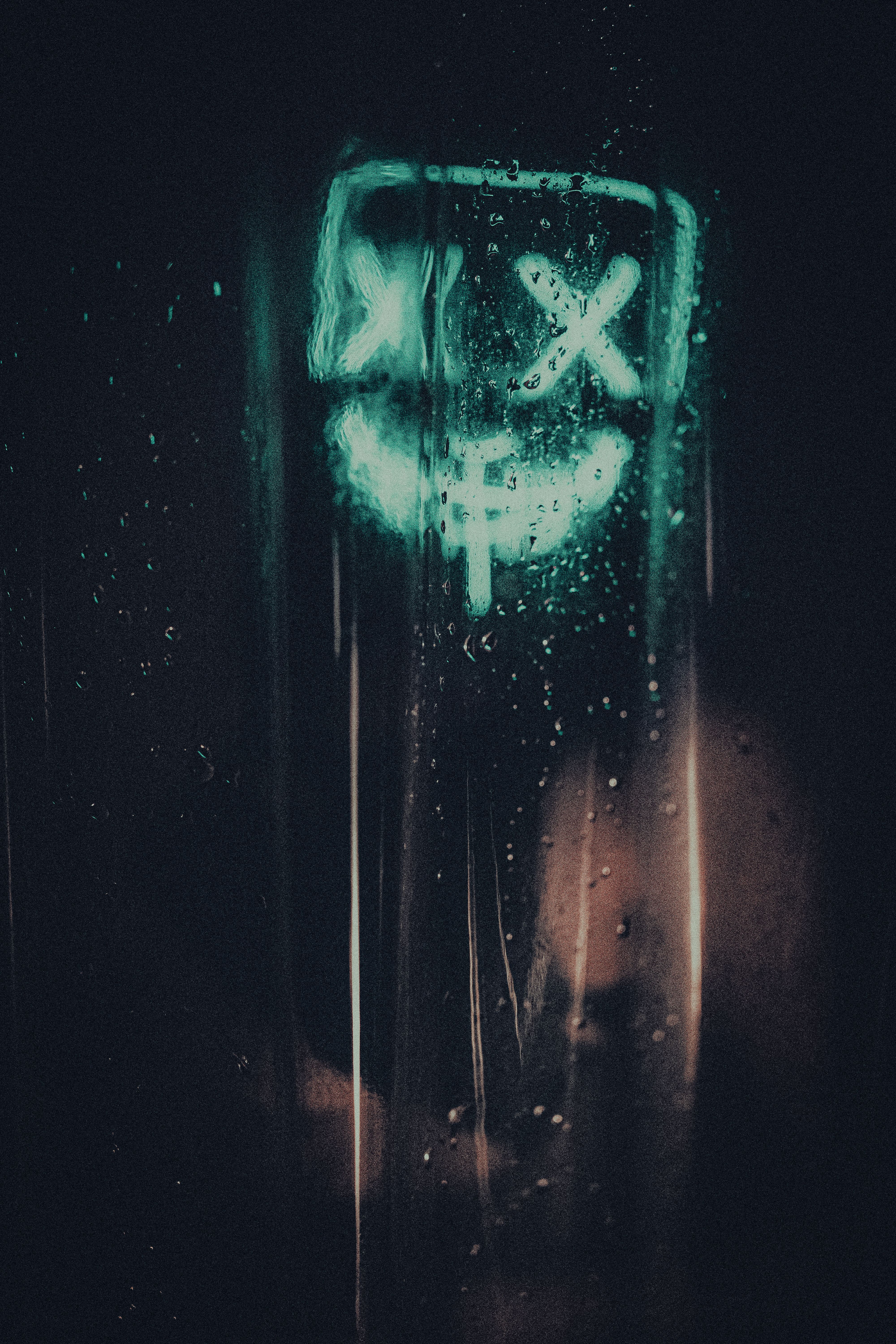 A person with a mask on their face in the rain · Free Stock Photo
