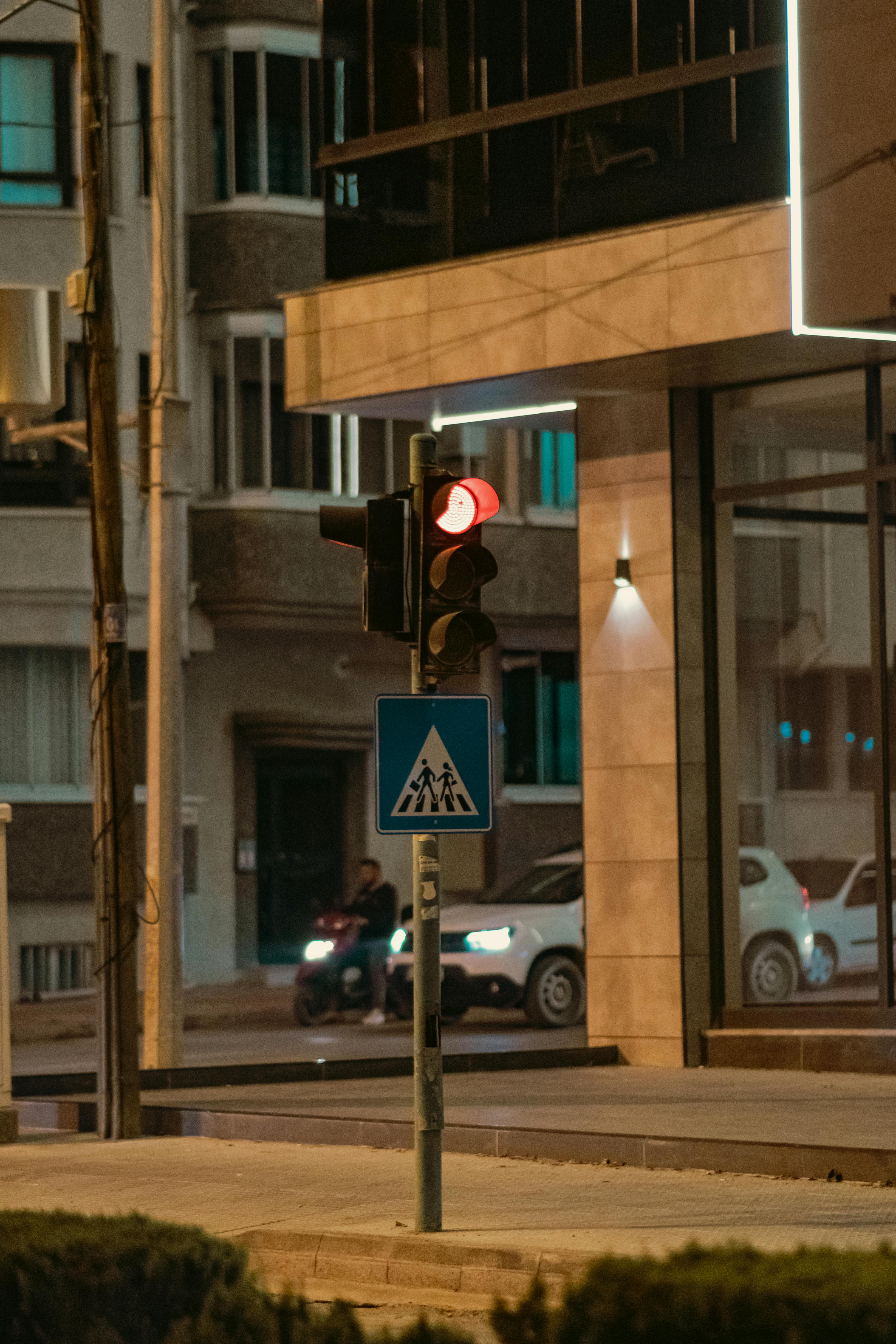 Traffic Light and Road Sign on Post on Sidewalk · Free Stock Photo