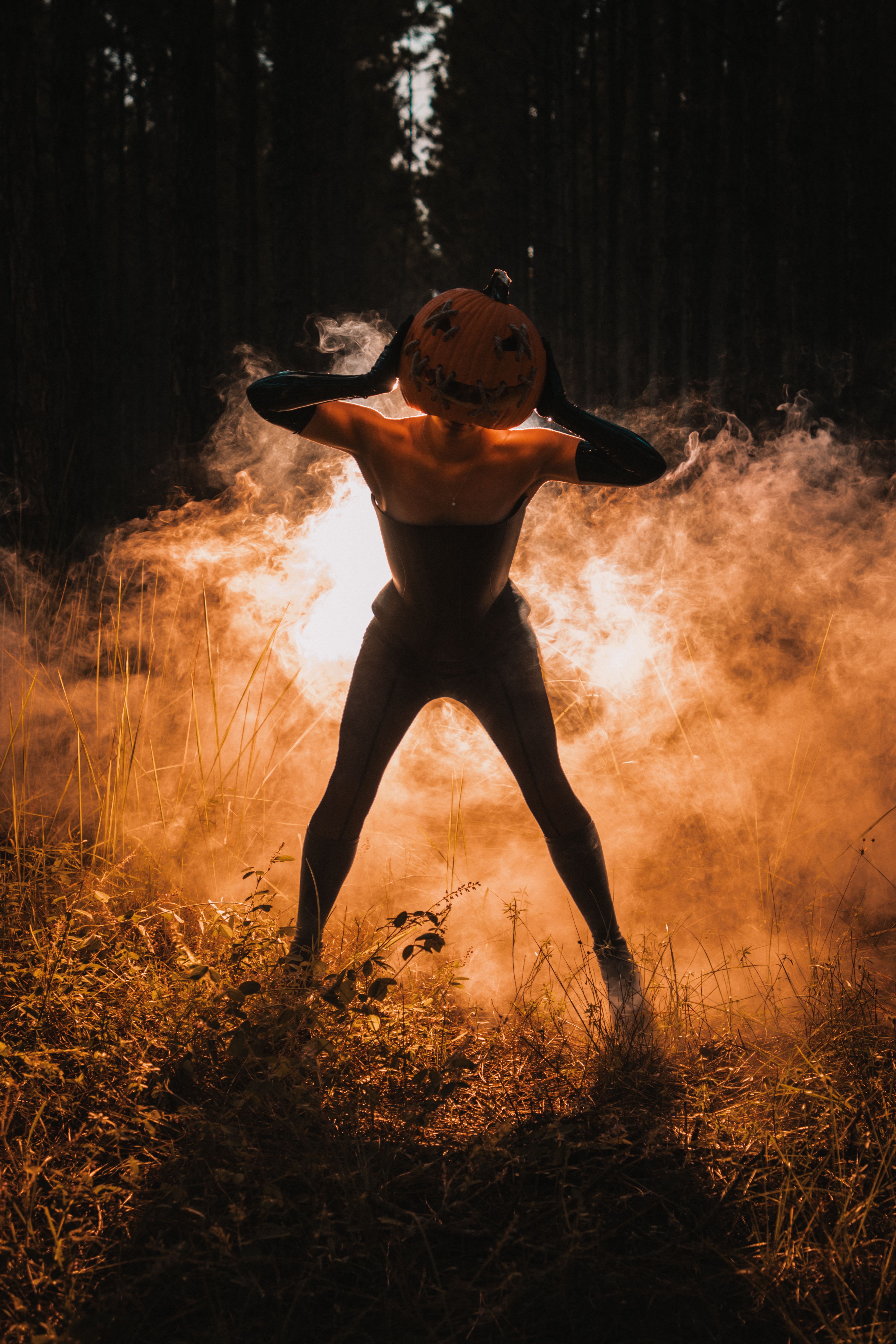 Woman in a Costume Holding a Carved Pumpkin Posing in the Forest · Free ...