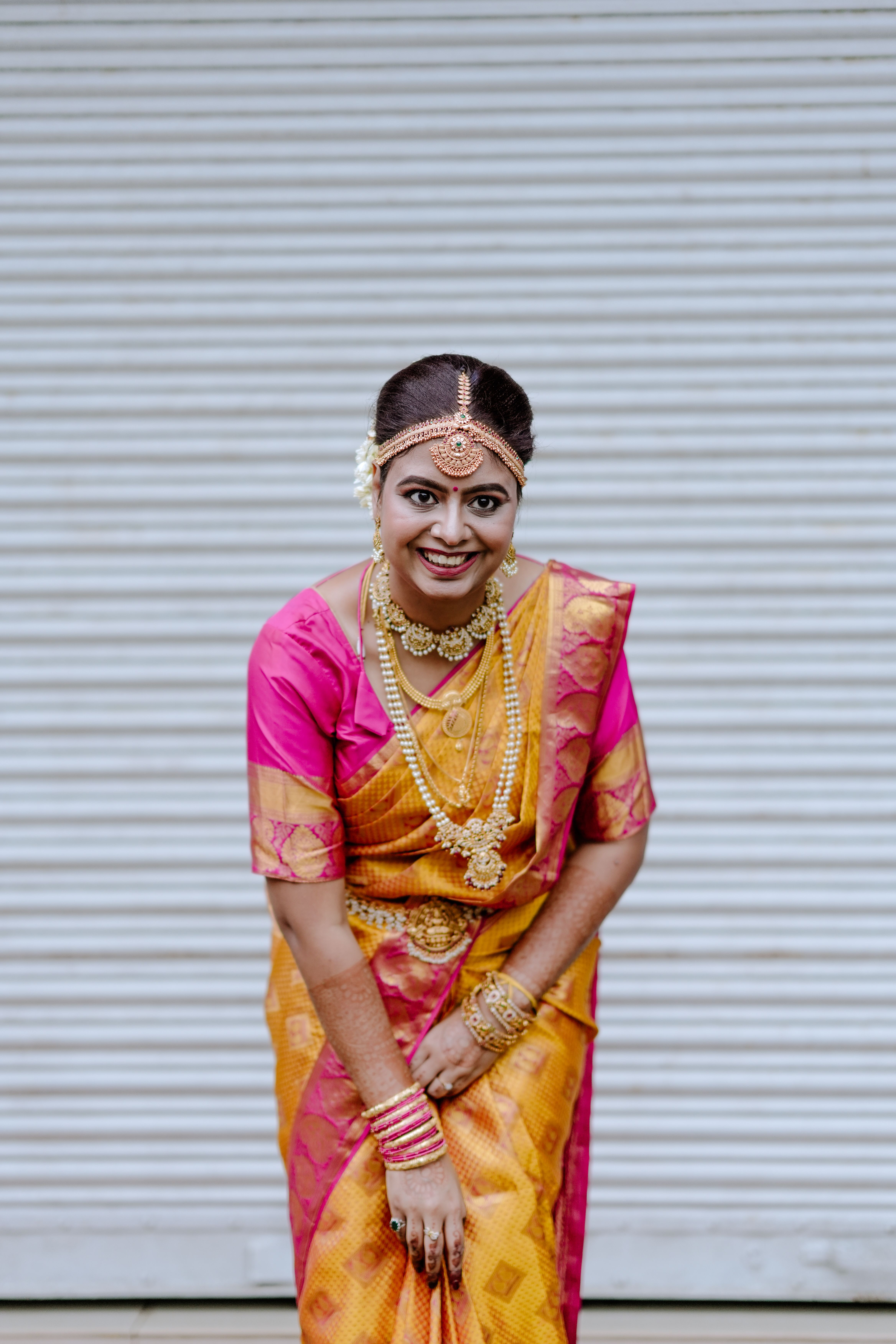 Old Woman in Traditional Dress near Brick Wall · Free Stock Photo
