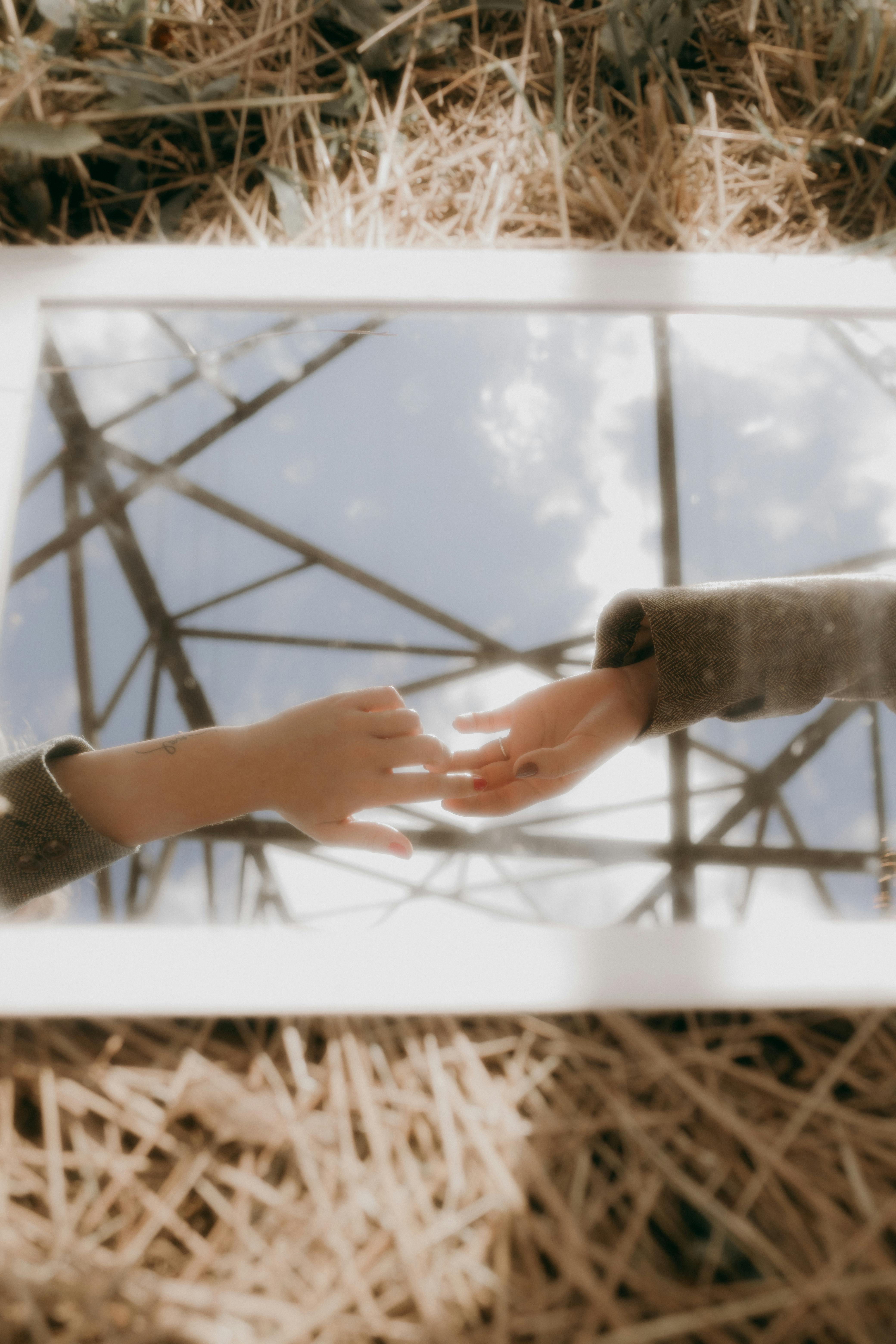 Mirror Fragments on Gray Surface With The Reflection Of A Person's Hand ...