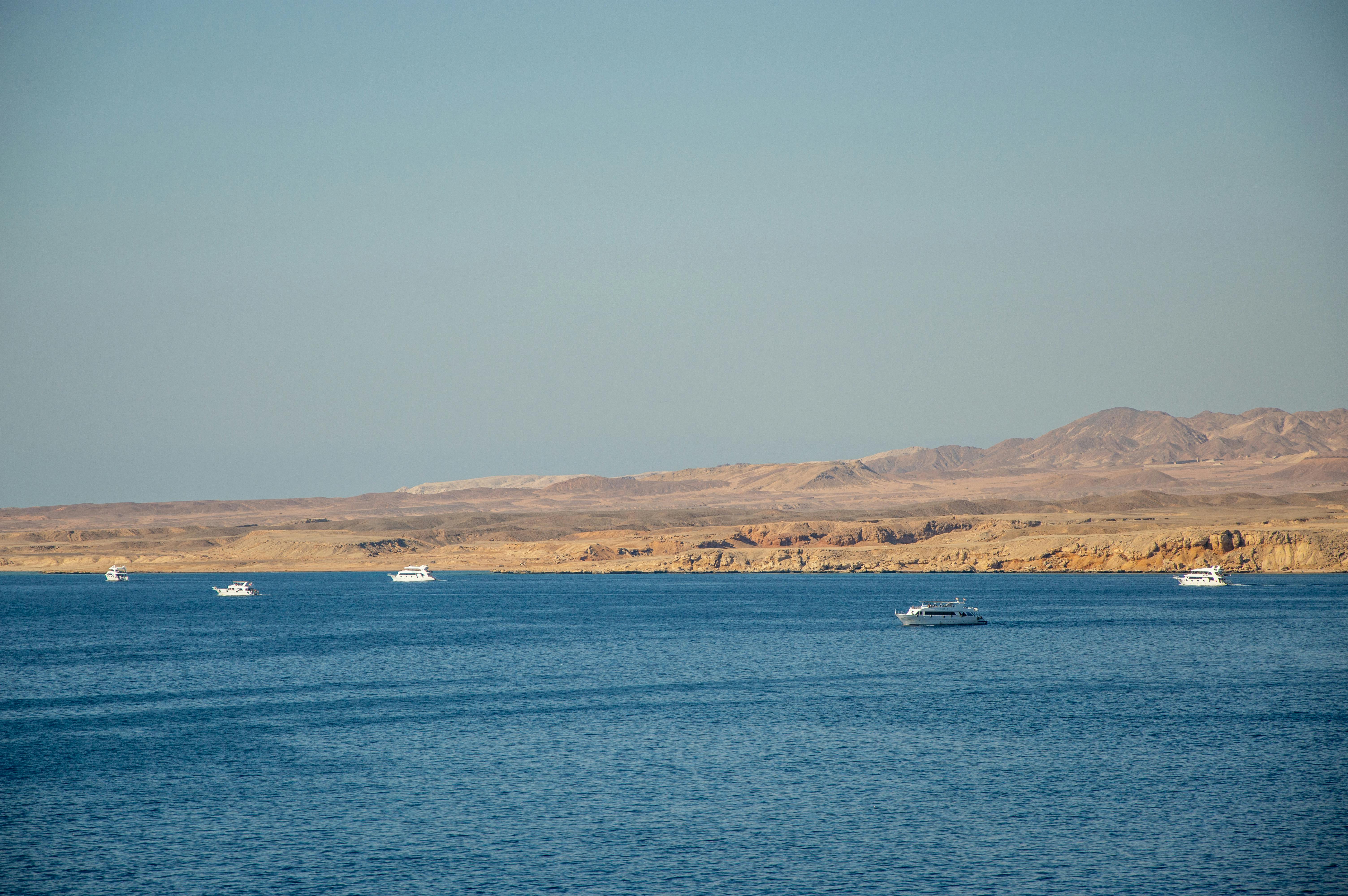Barren Coast and Ferries on the Sea · Free Stock Photo