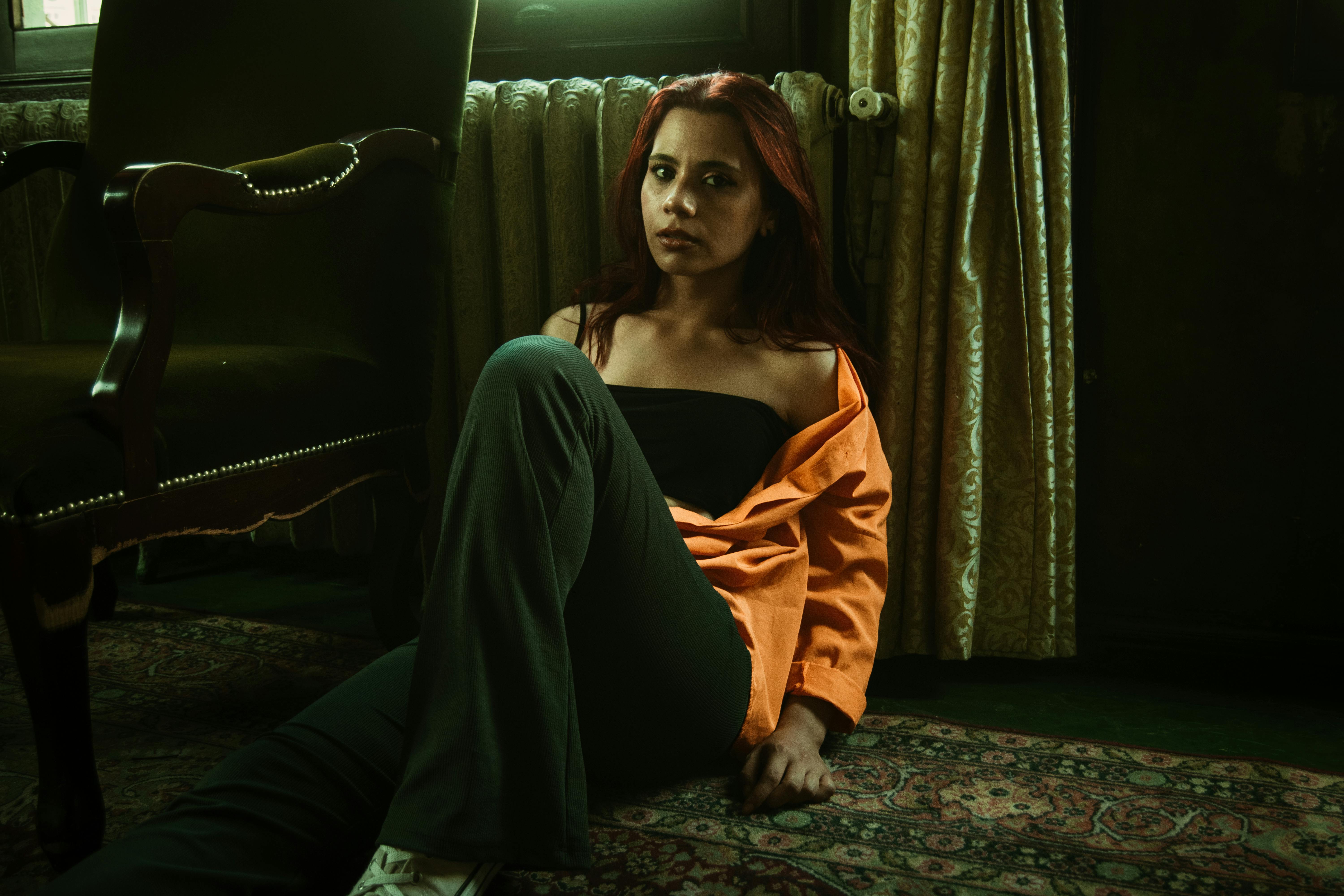 Woman Sitting on Rug by Radiator · Free Stock Photo