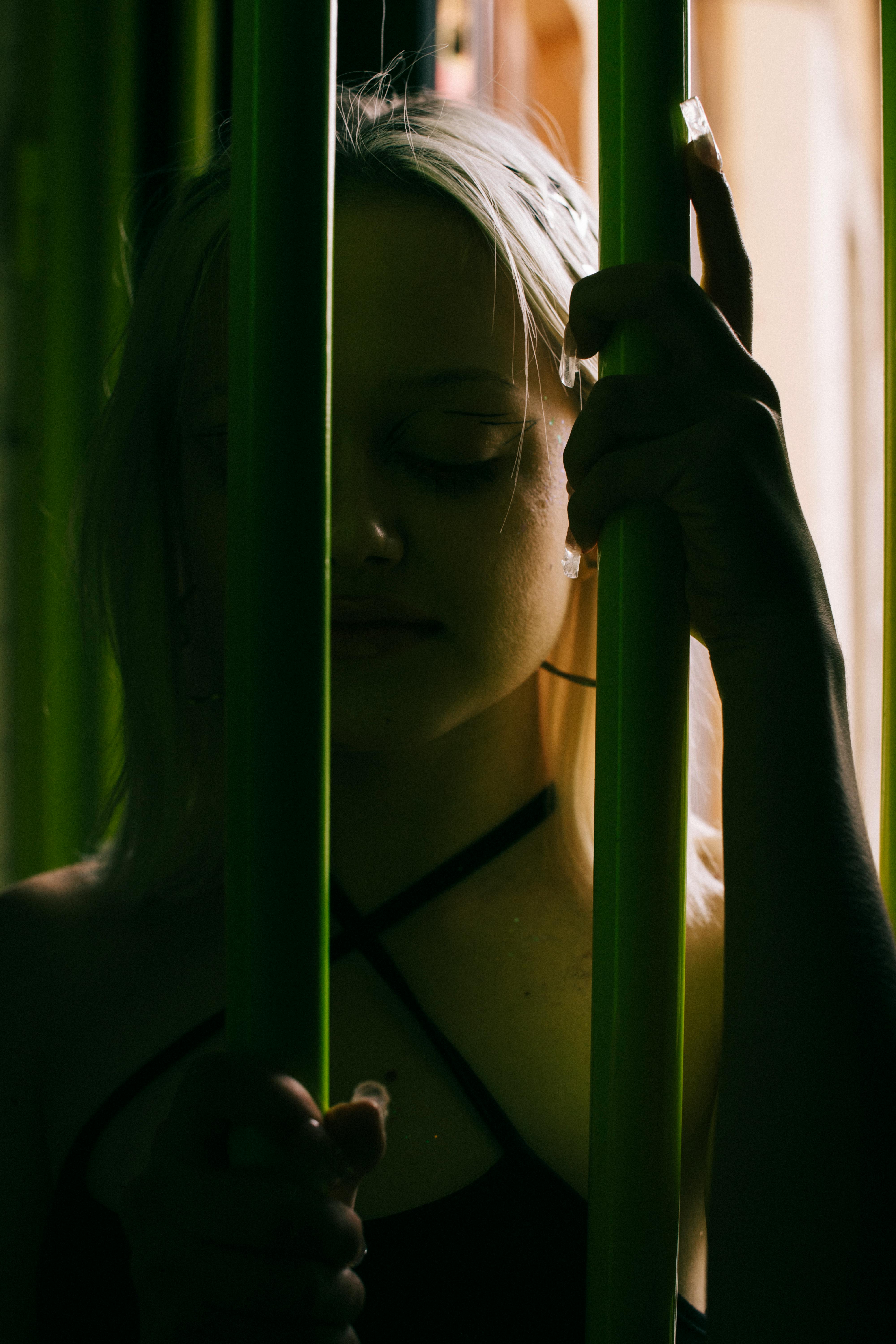 Portrait of Woman behind Bars · Free Stock Photo