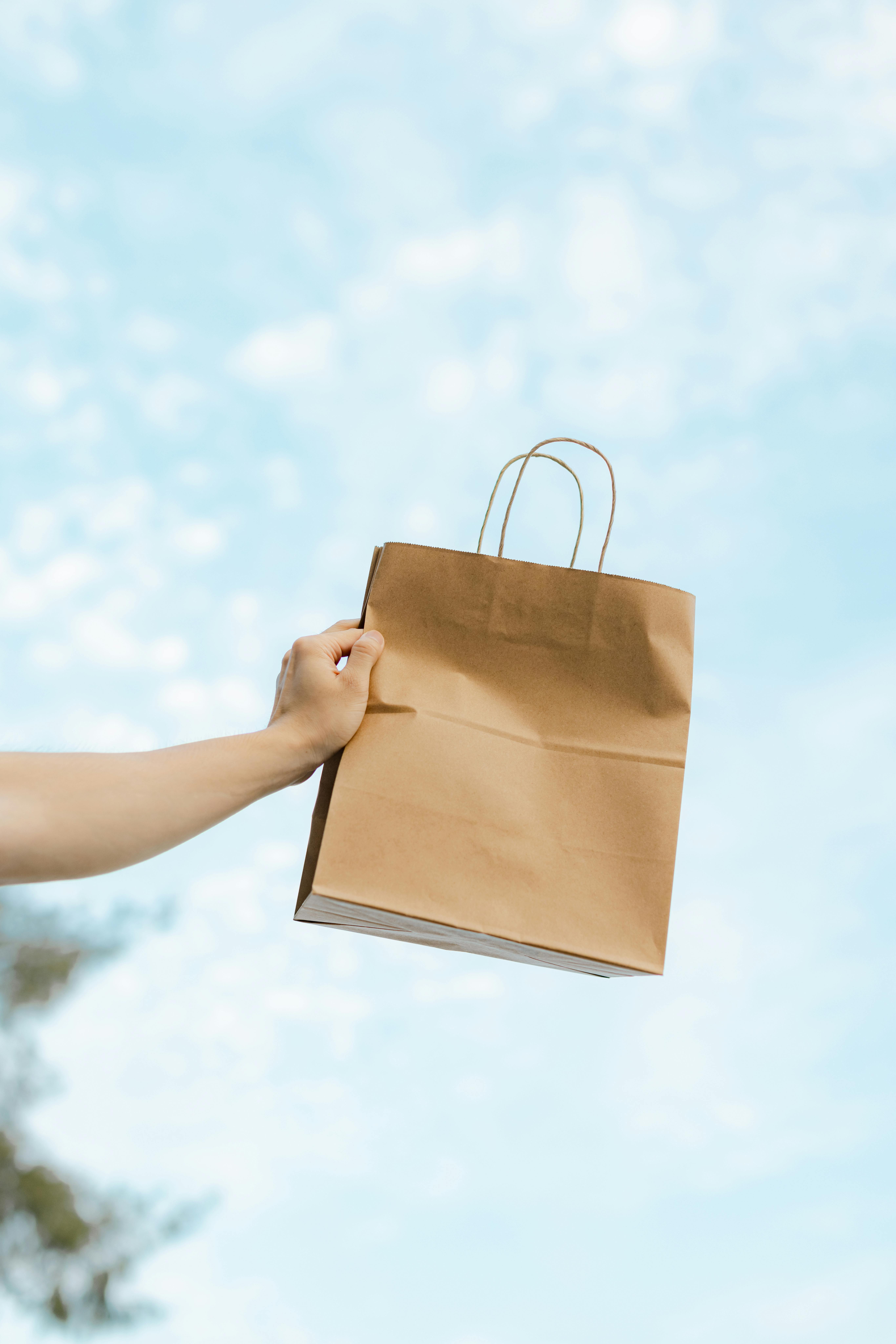 Hand with a Ring, Paper Cup, Handbag and Flowers in a Shopping Bag ...
