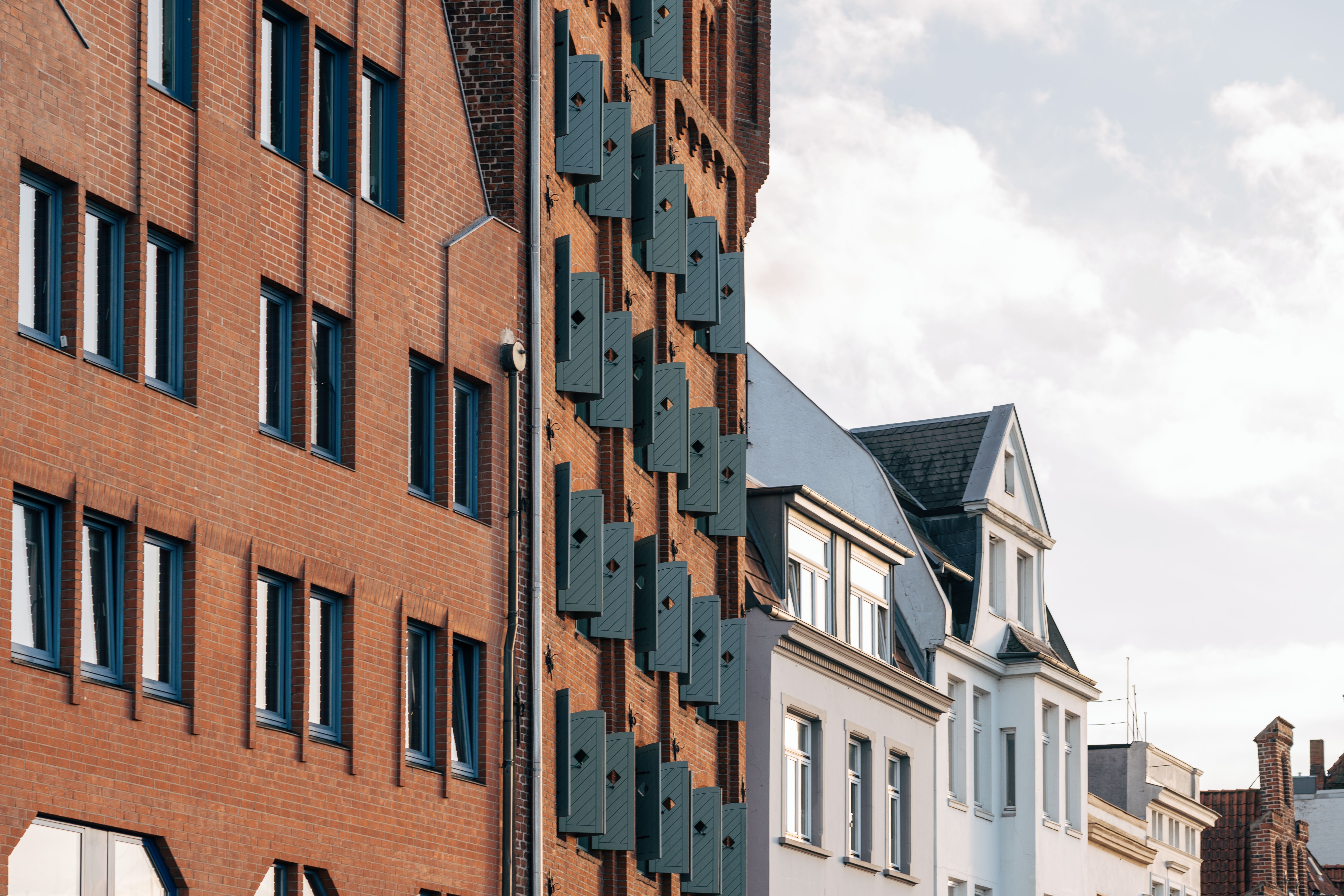 Open Shutters of a Gothic Red Brick Building · Free Stock Photo