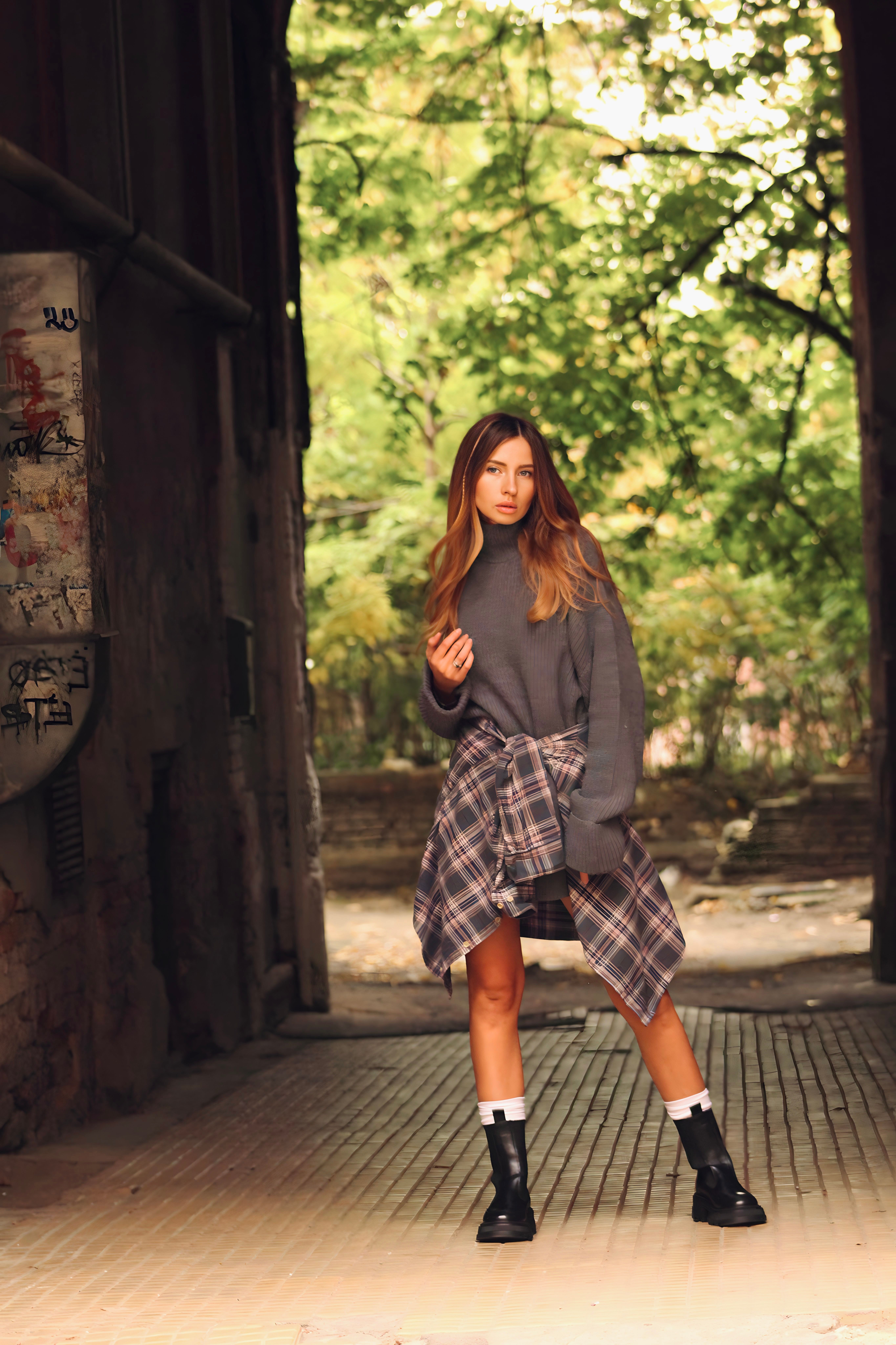 Woman Posing in Gray Sweater and Checked Shirt Wrapped around her Waist ...