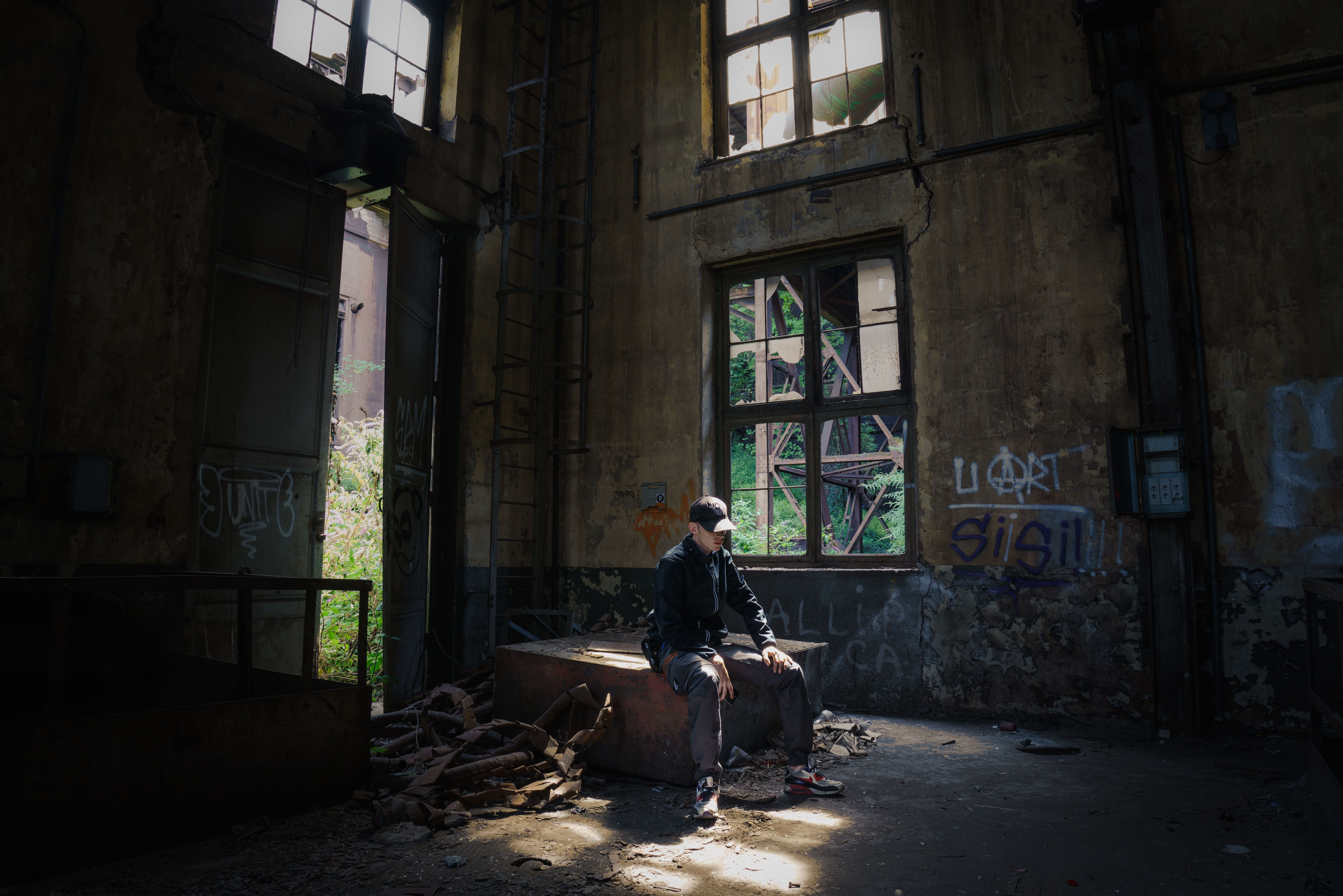 Man Sitting in an Abandoned Building · Free Stock Photo