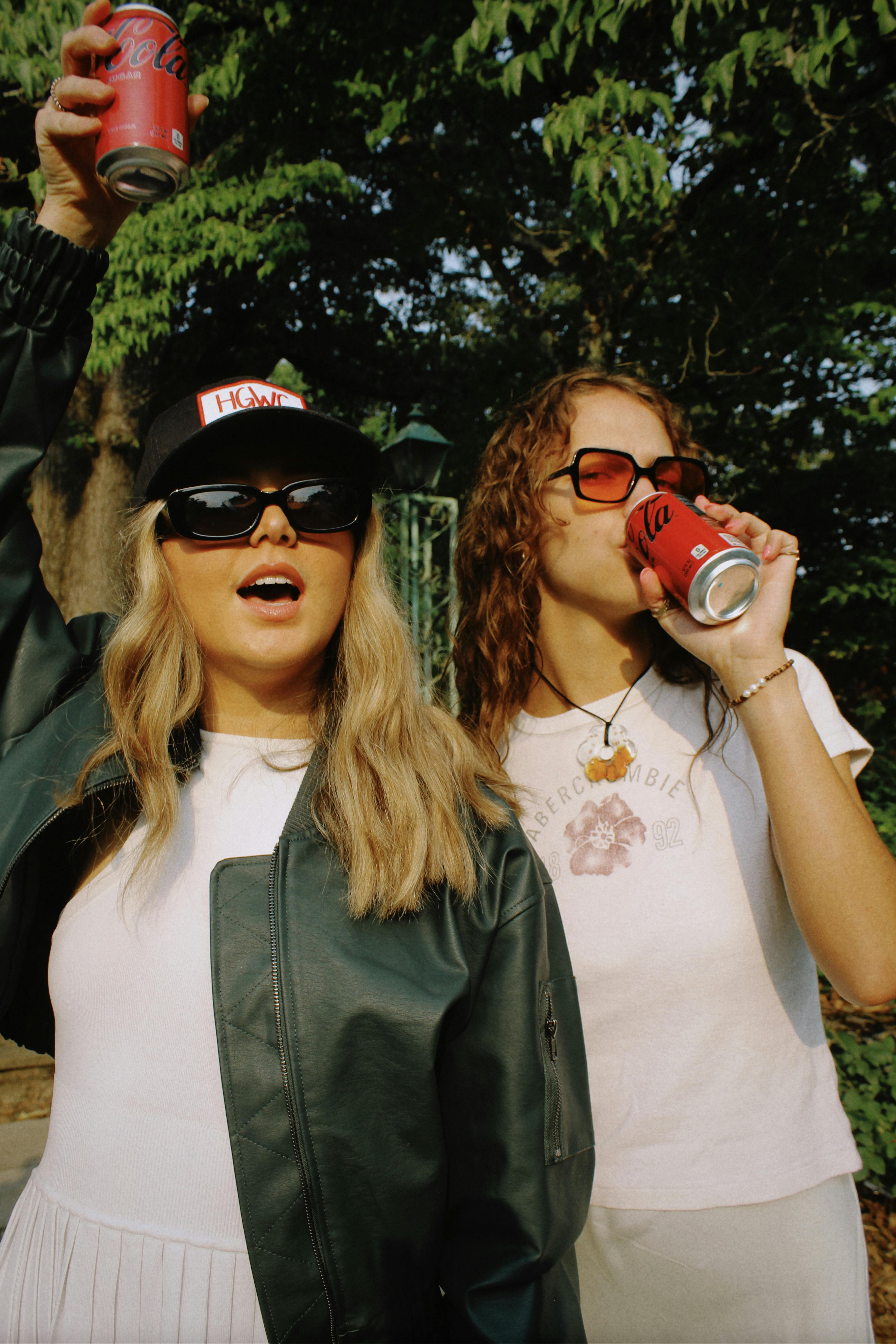 Women Drinking Coke in a Park · Free Stock Photo