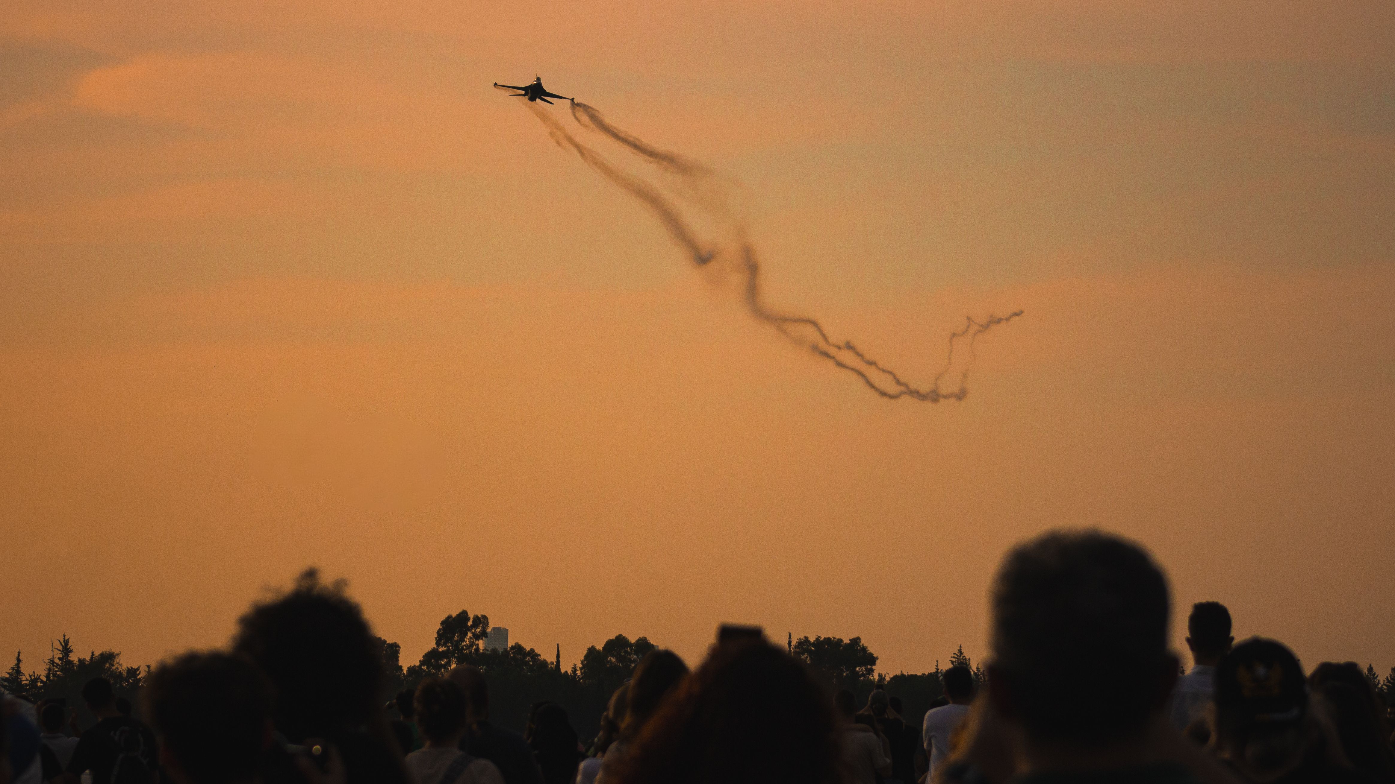 A Crowd Watching a Plane Flying at Sunset · Free Stock Photo