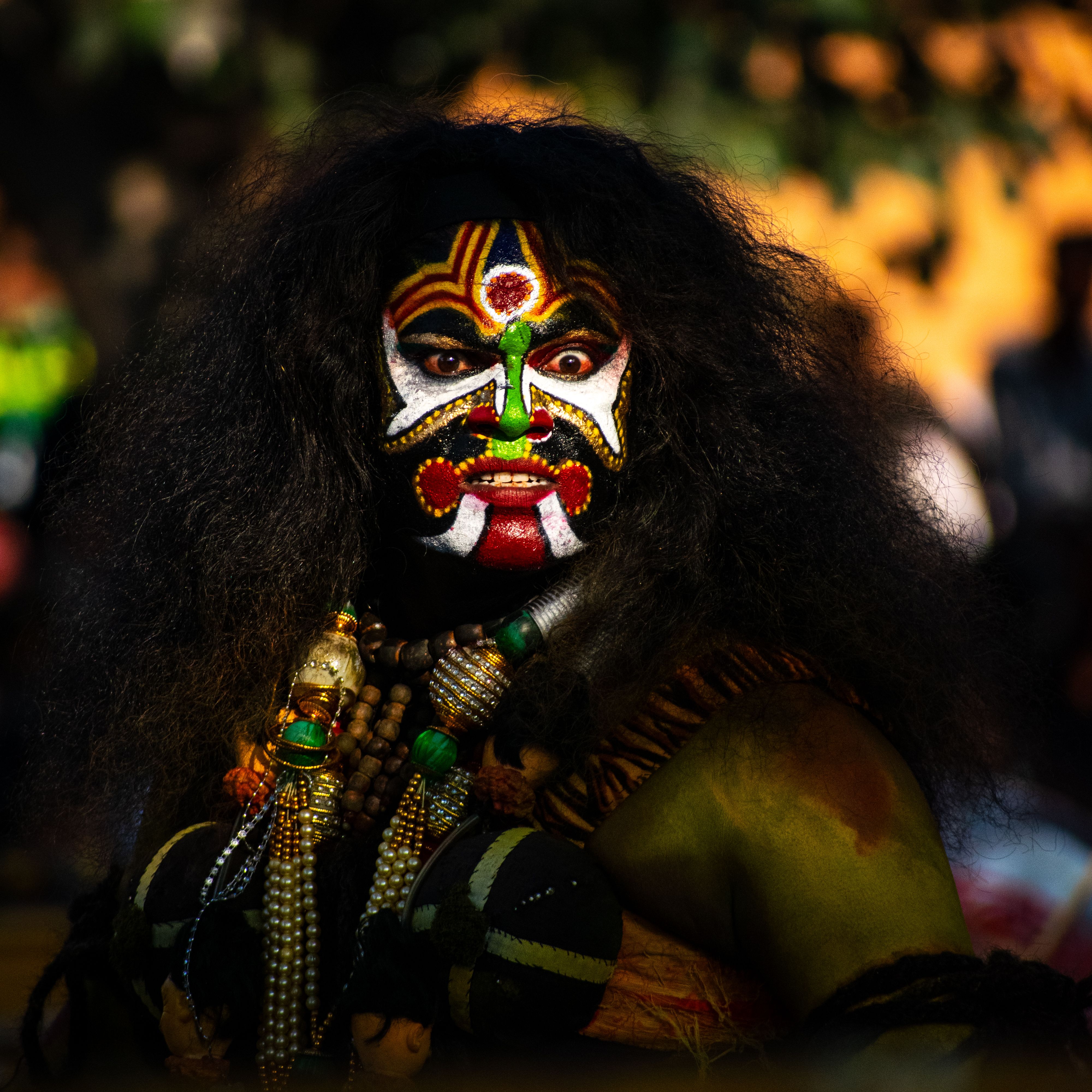 Person With Face Paint Behind Leaves Of A Plant · Free Stock Photo