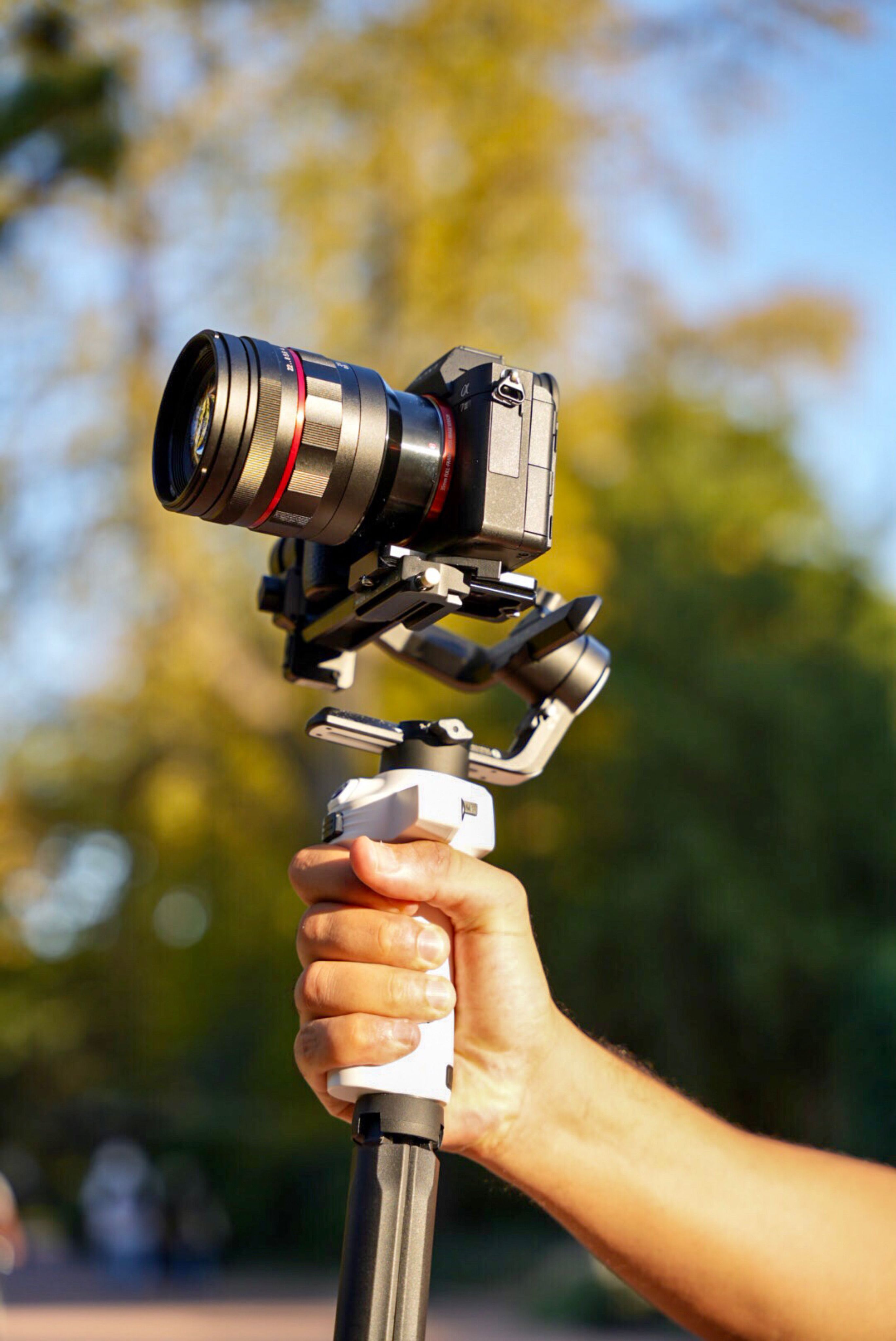 Man Holding a Camera in his Hand · Free Stock Photo