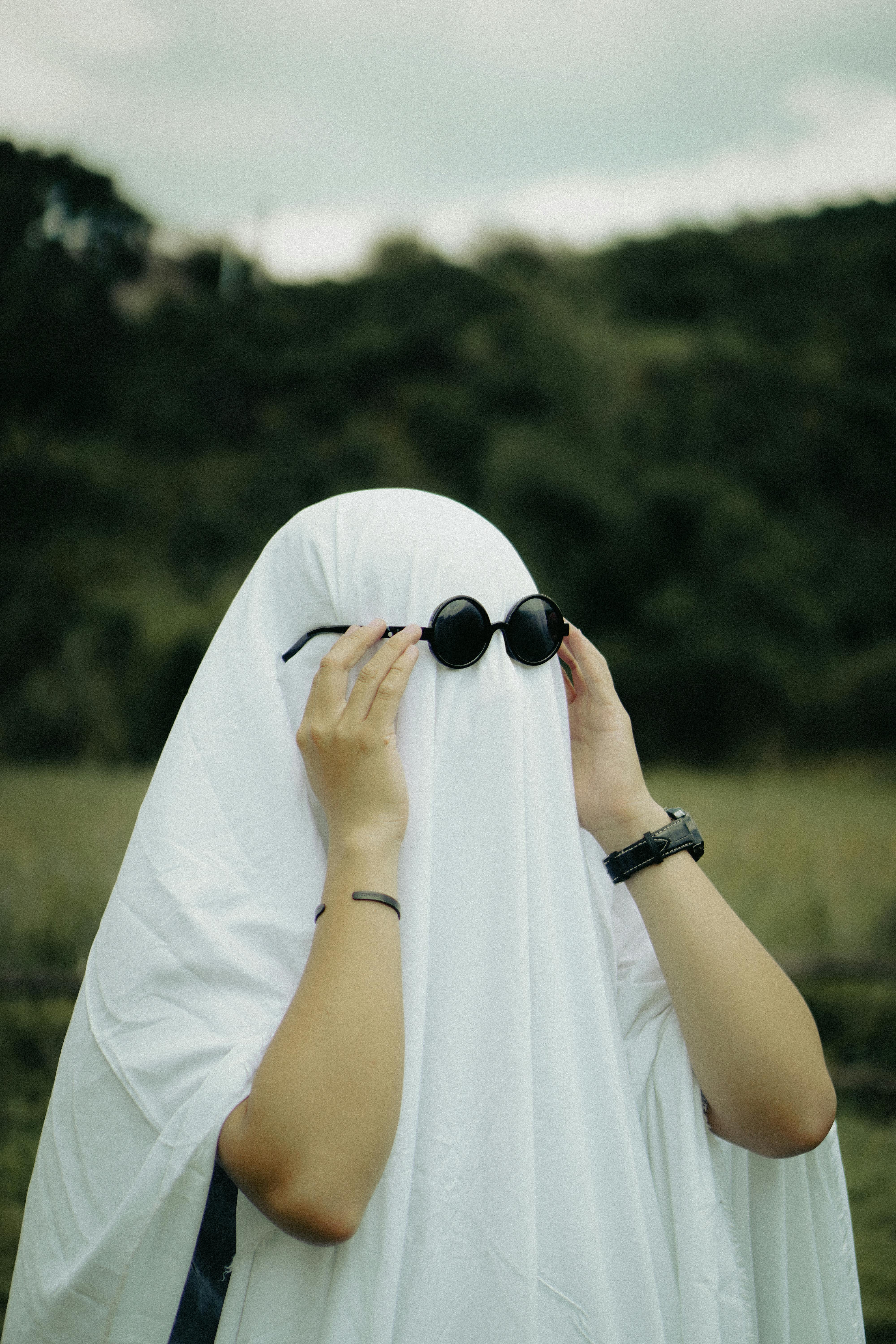 Person Dressed as a Ghost Wearing Sunglasses · Free Stock Photo