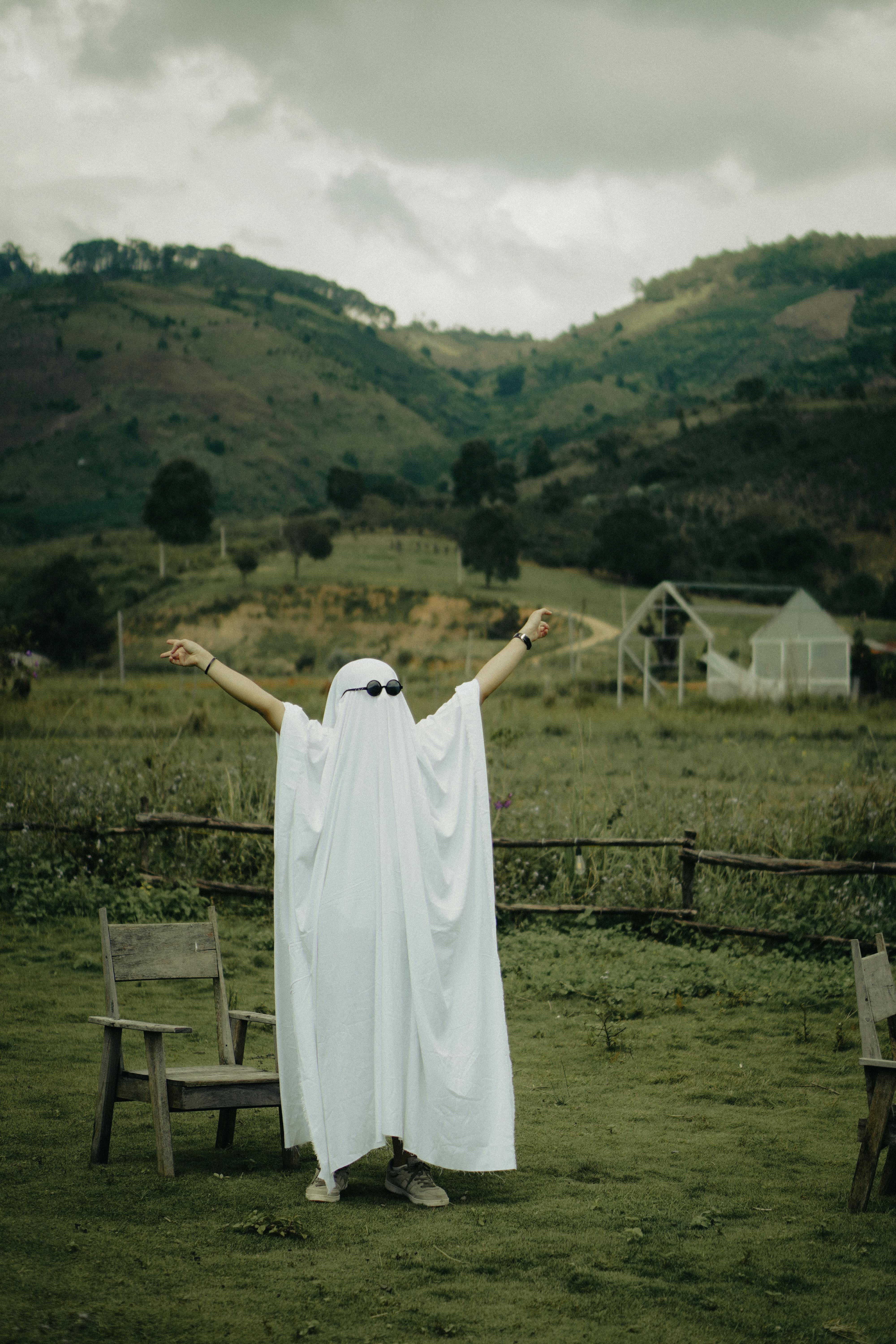 Ghost with Arms Raised in Countryside · Free Stock Photo