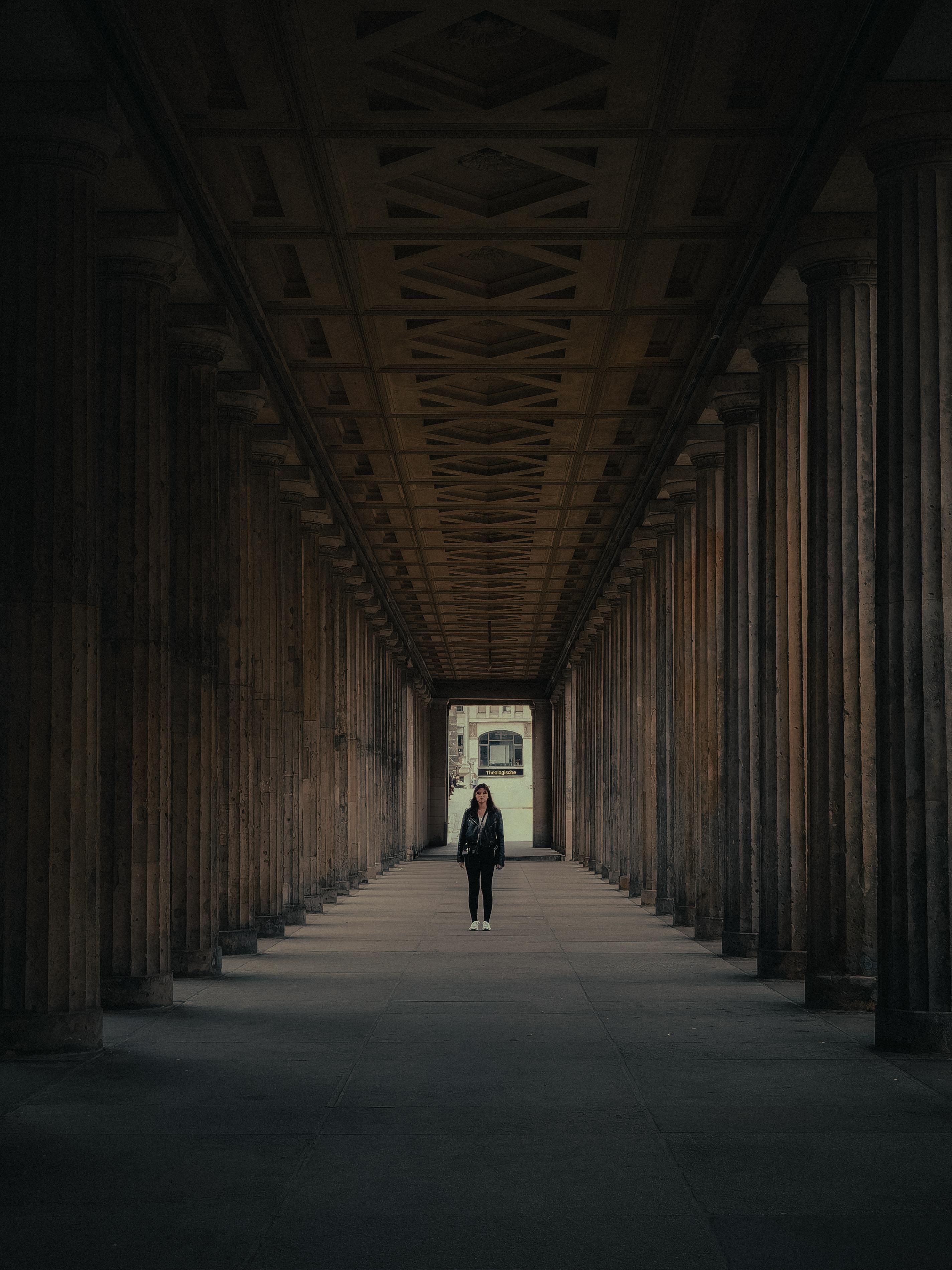 Passersby Between the Colonnades of the Arcade · Free Stock Photo