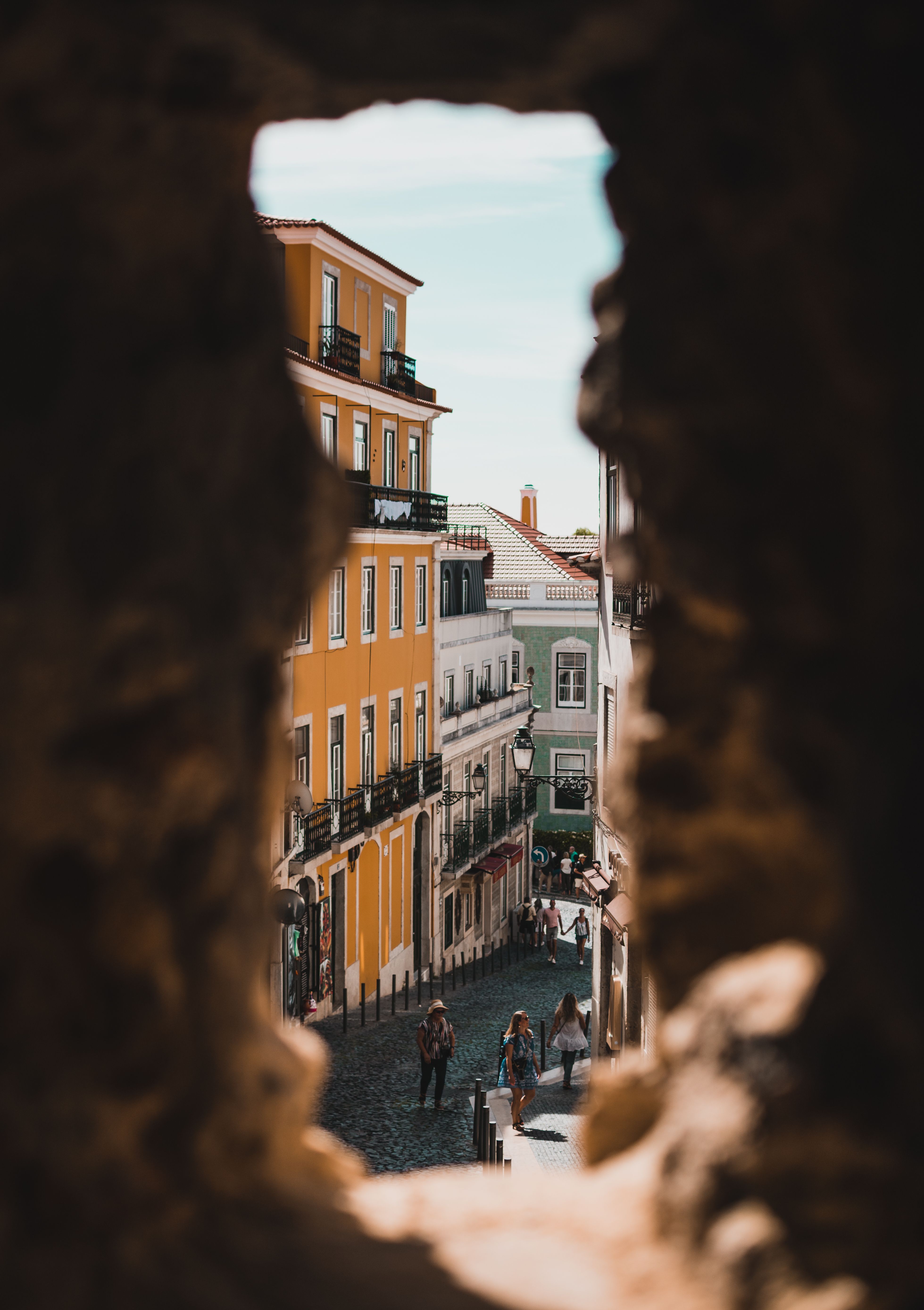 Cobblestone Street behind Stone Window Opening in Lisbon · Free Stock Photo