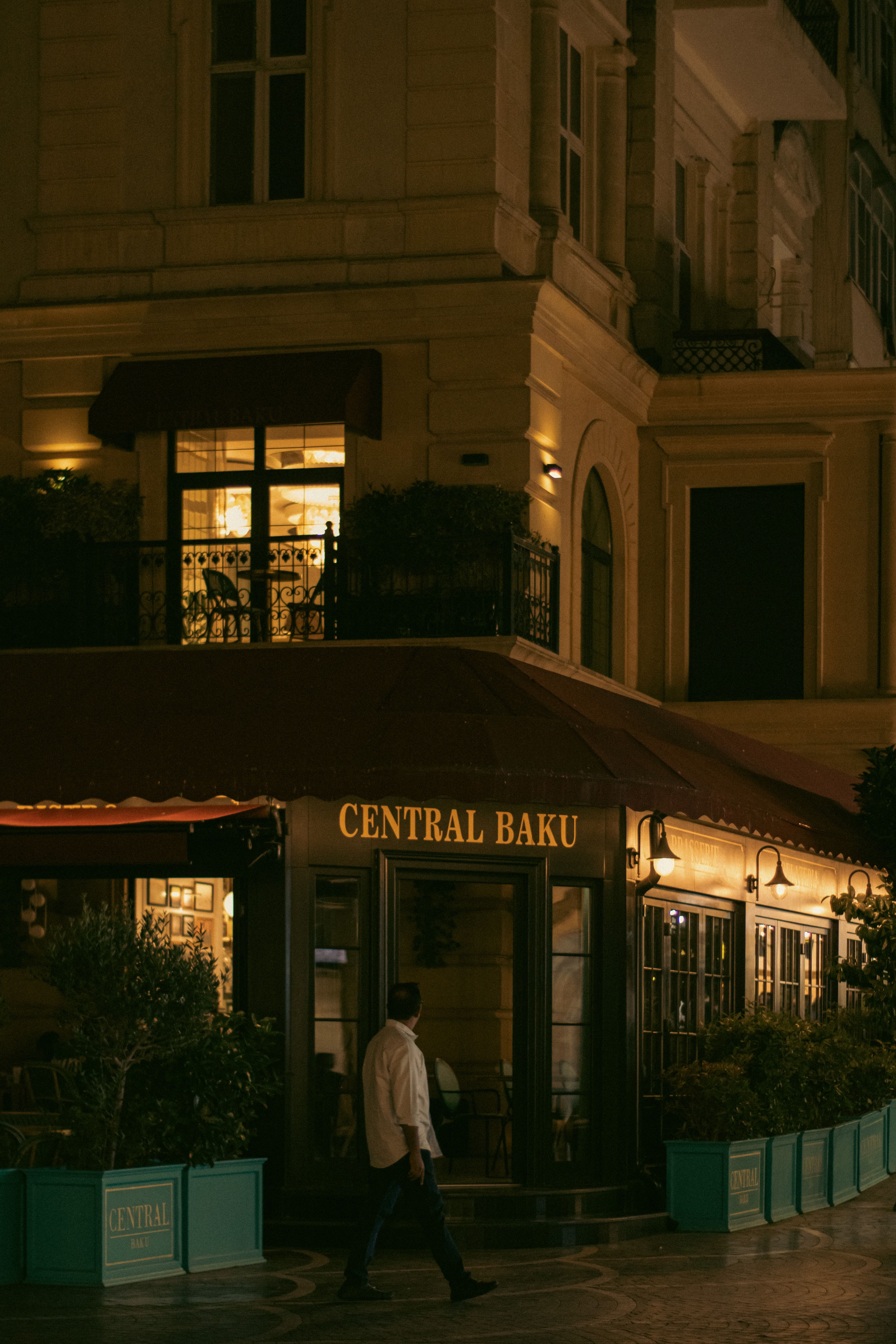 Man Walking near Central Baku Restaurant · Free Stock Photo