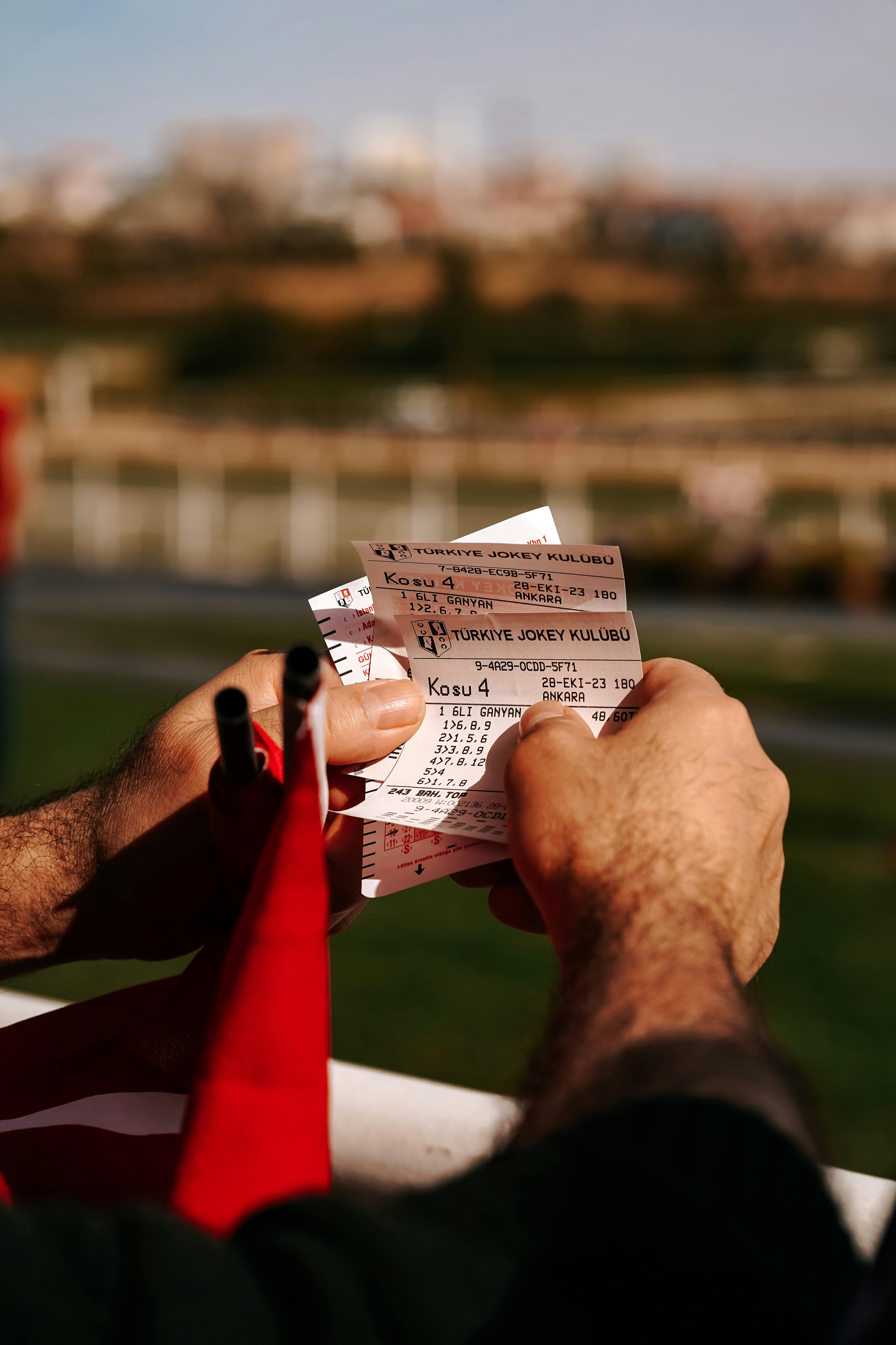 Closeup of a Man Holding Tickets on a Ferry · Free Stock Photo