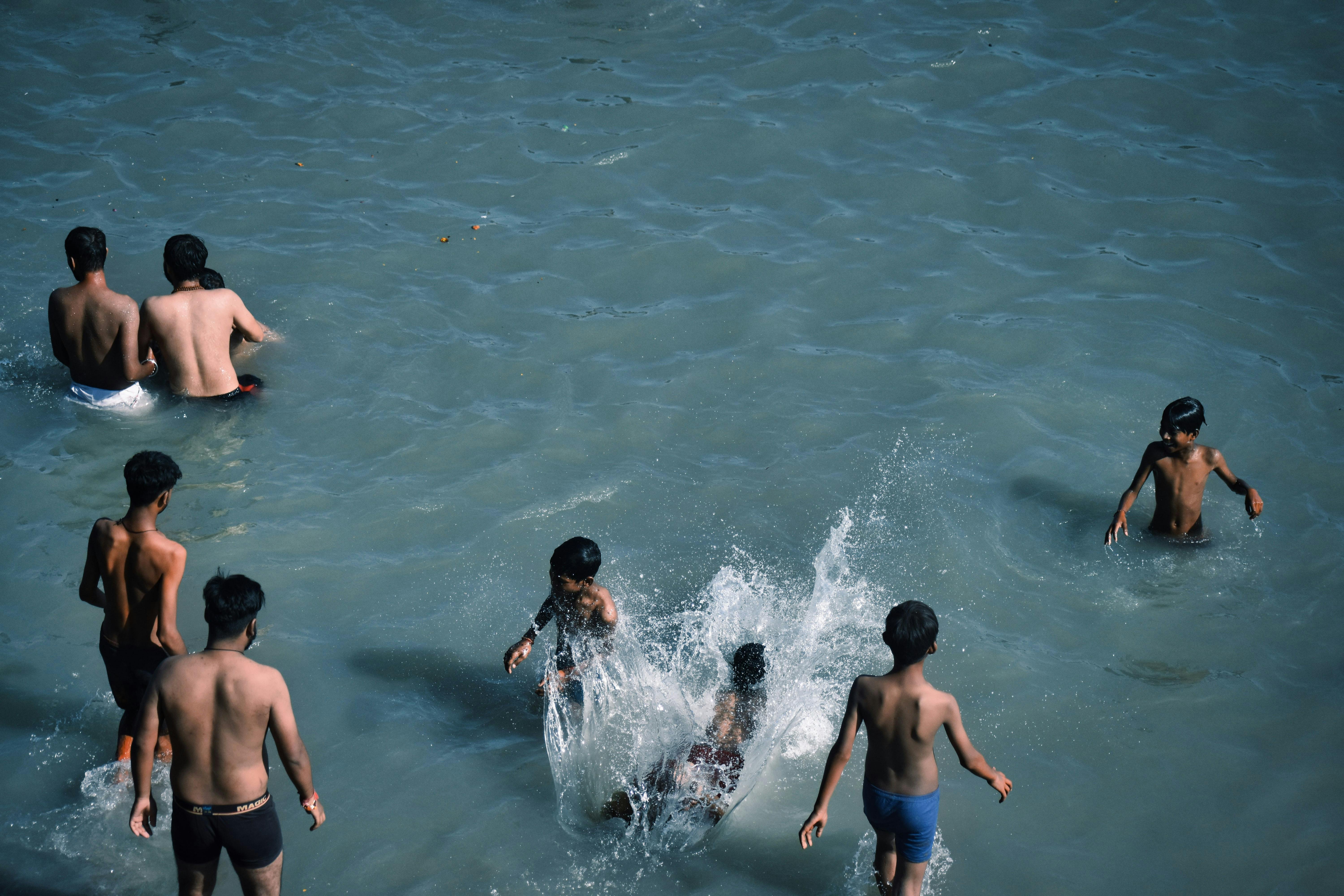 People Swimming in Shiny Water · Free Stock Photo