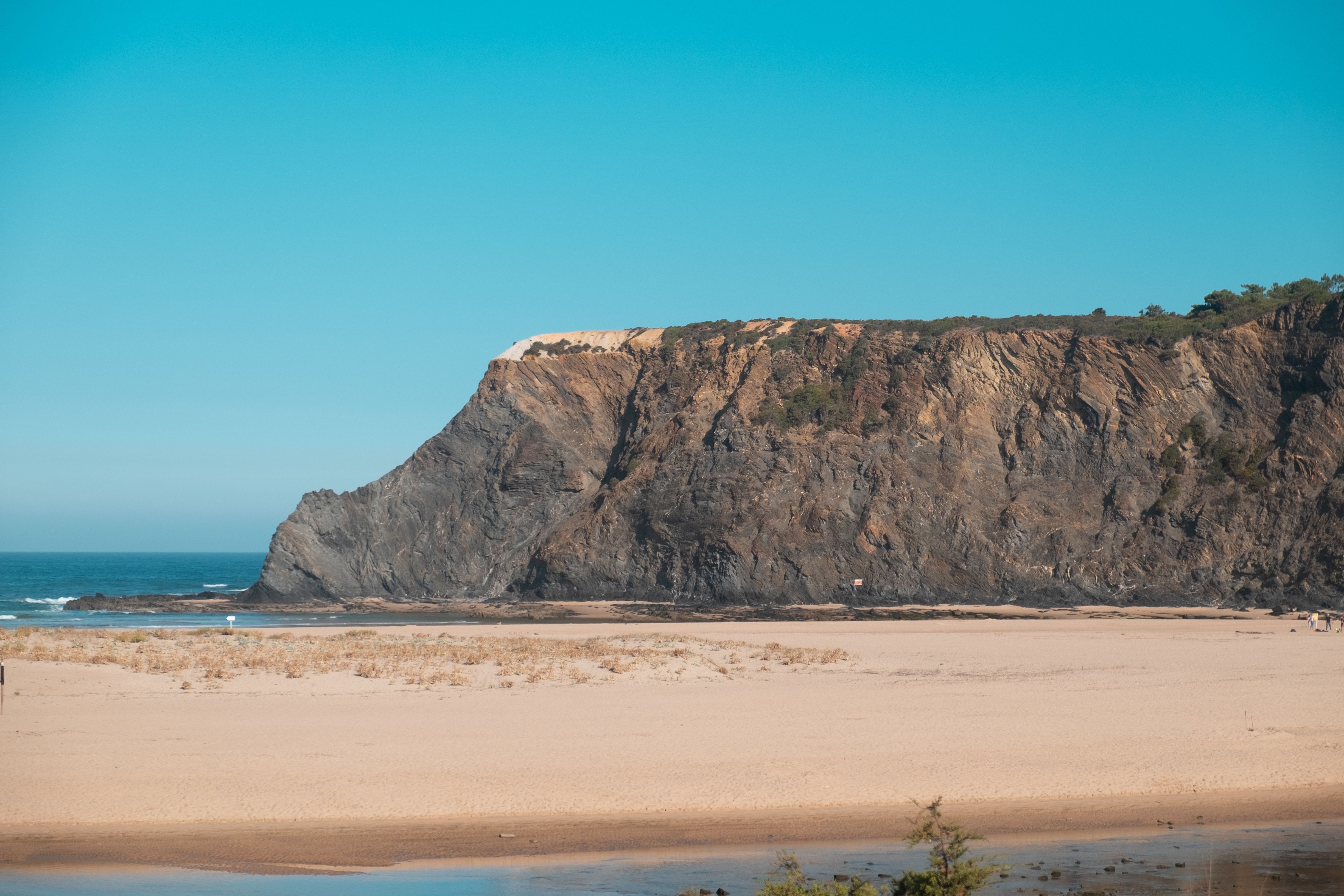 Beach and Cliff on Sea Shore · Free Stock Photo