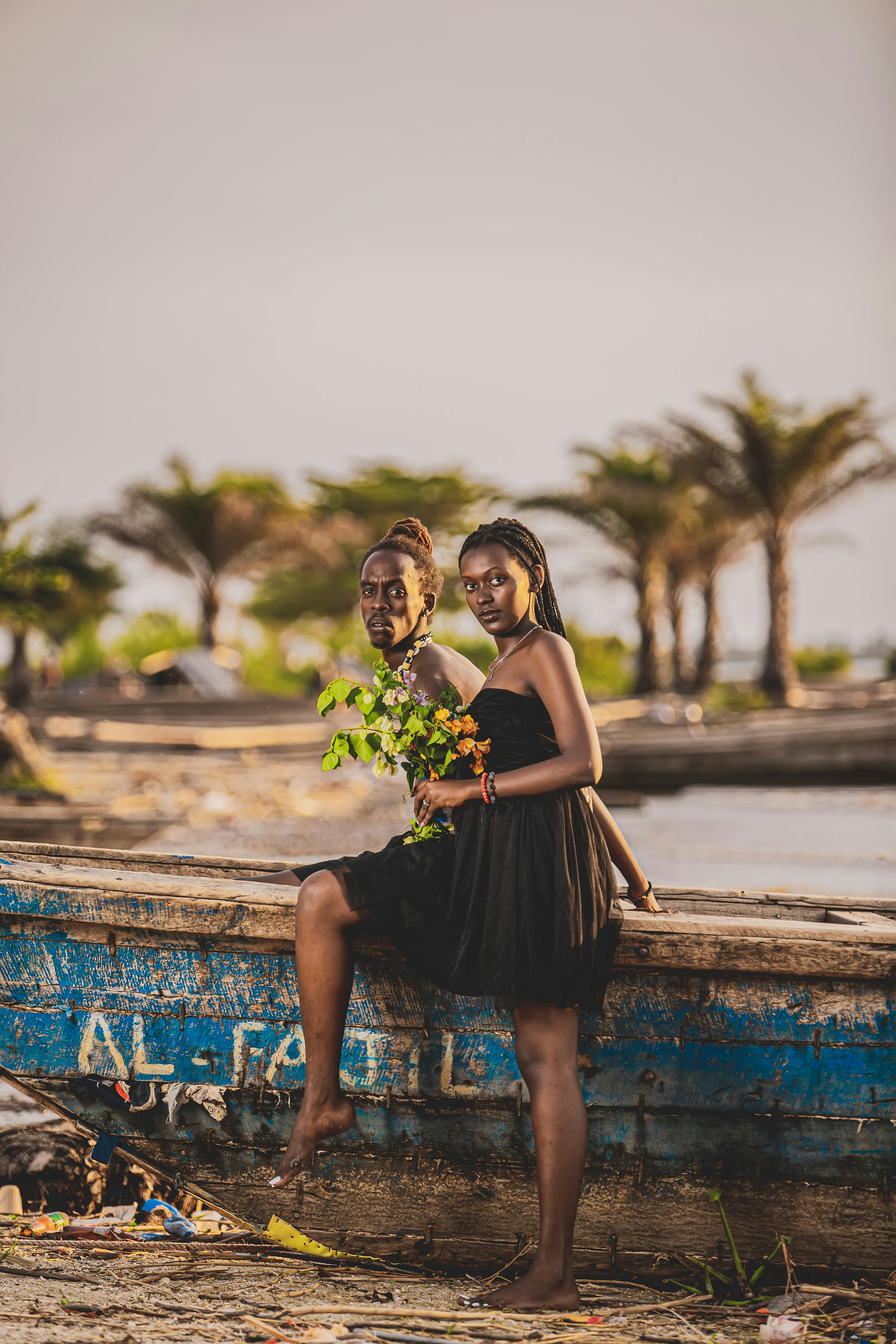 Couple on an Old Wooden Fishing Boat on the Beach · Free Stock Photo