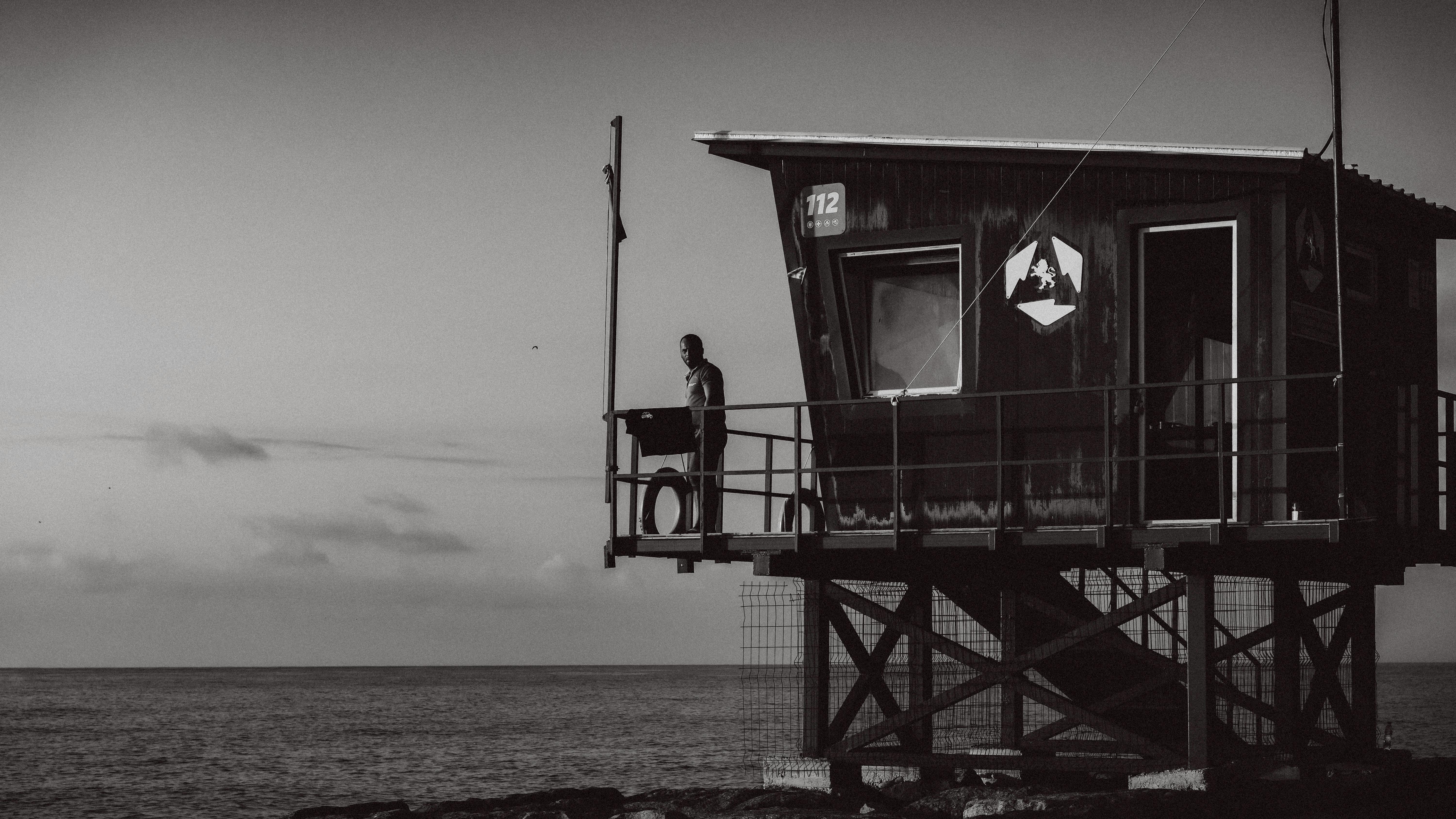 White Wooden Lifeguard House Near Shoreline · Free Stock Photo