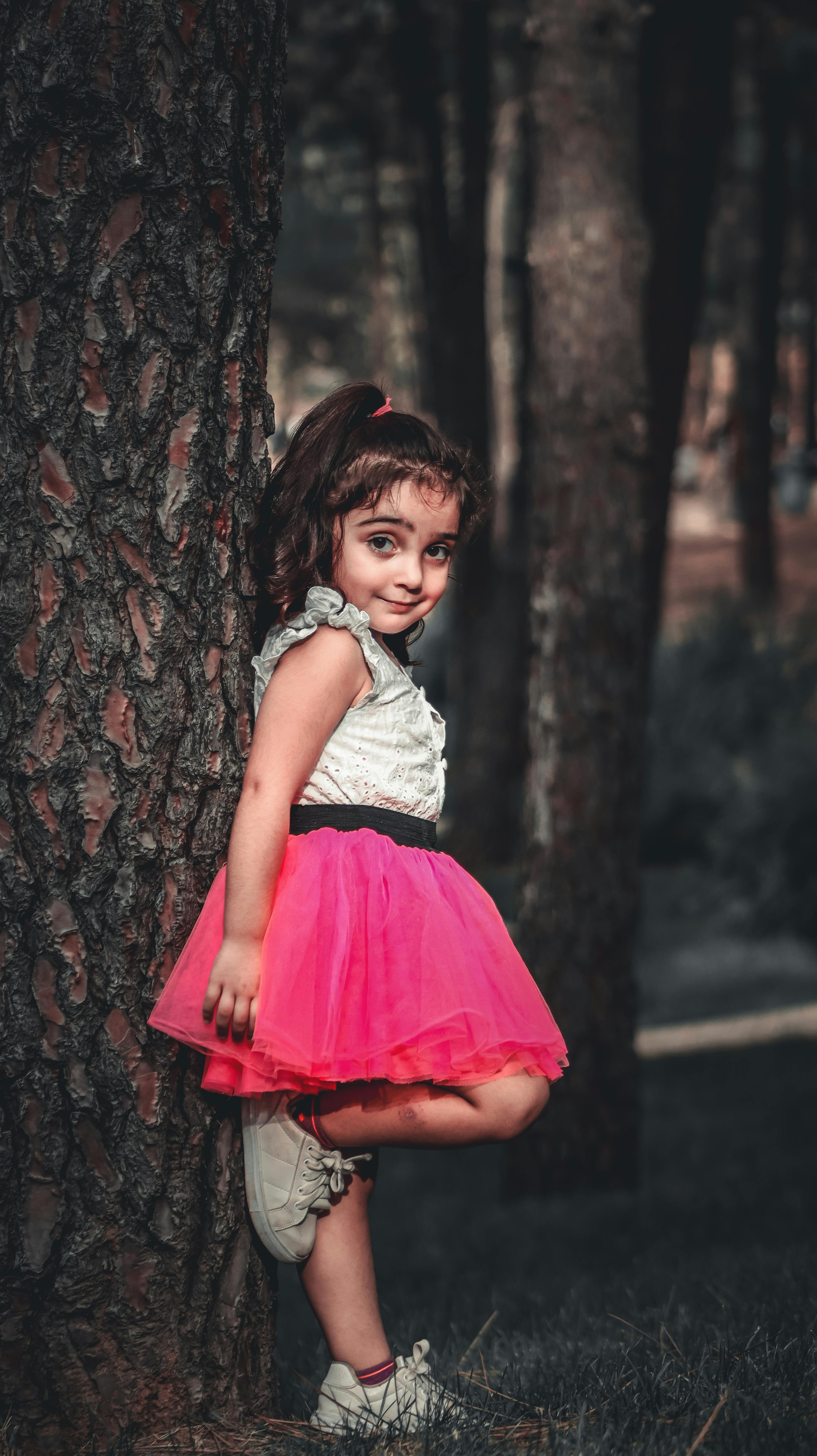 Cute Girl Posing near Stone Wall · Free Stock Photo