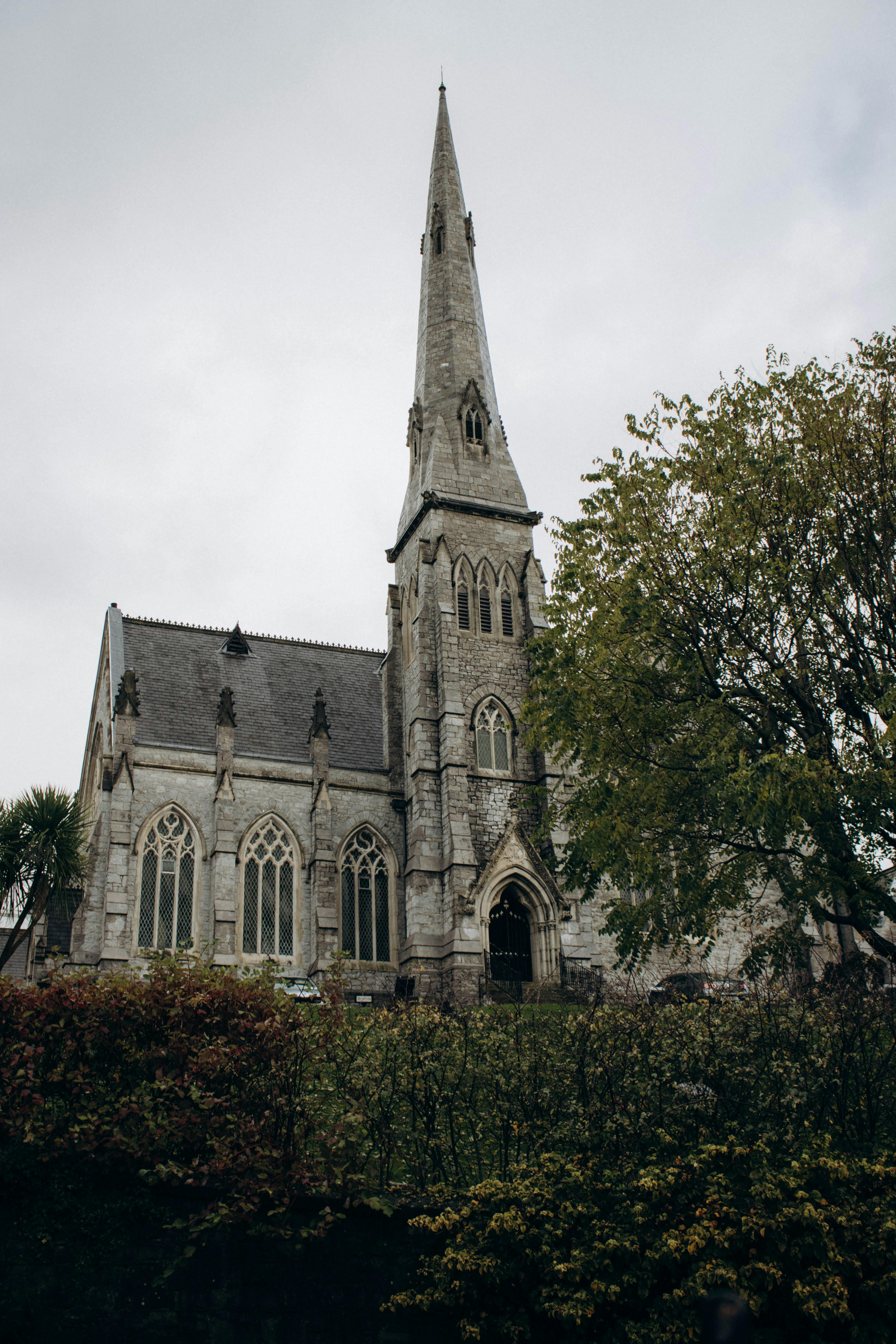 Gray Image of a Gothic Church with a Spiky Tower · Free Stock Photo