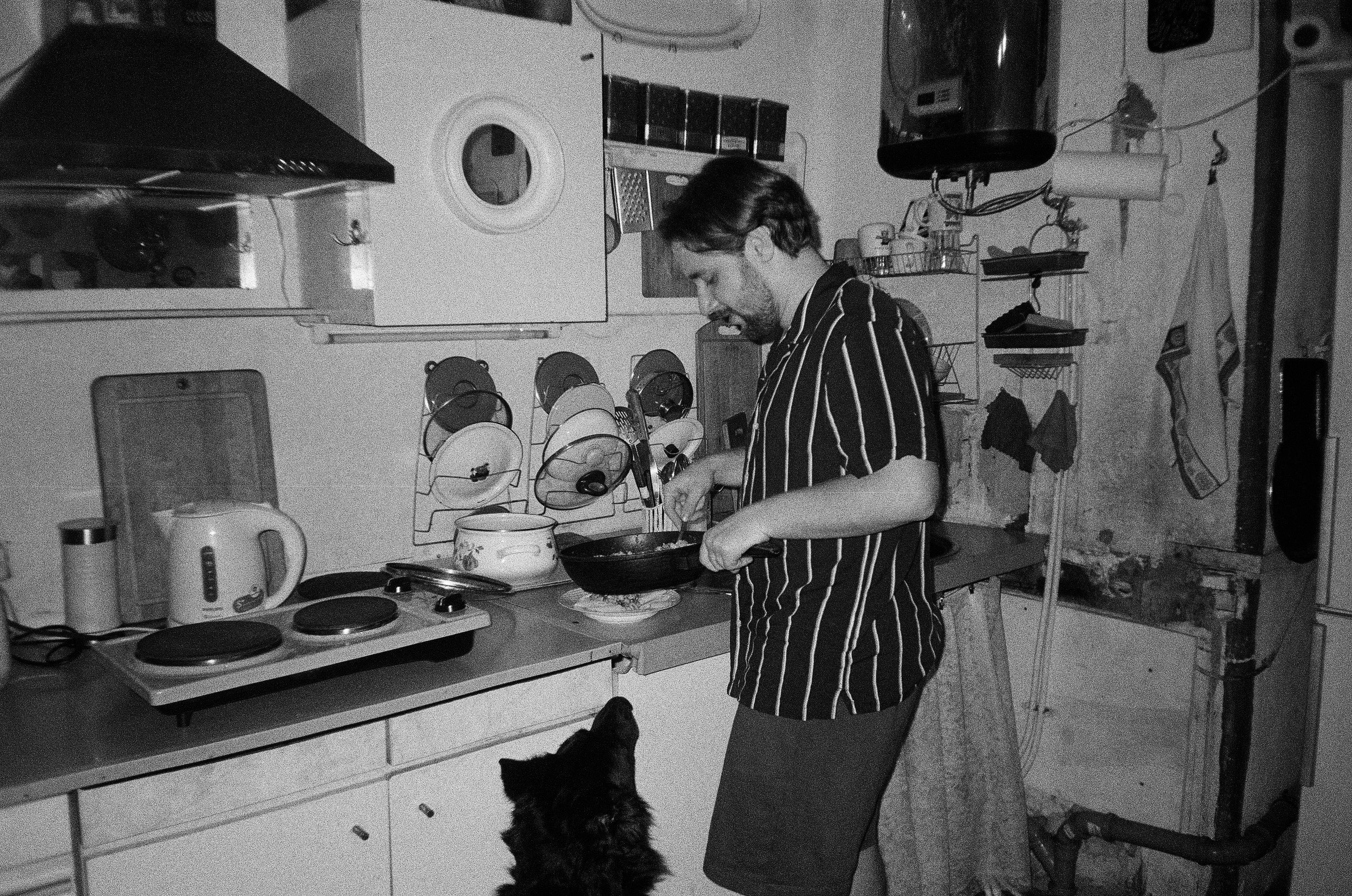 Man in Shirt Cooking in Kitchen in Black and White · Free Stock Photo