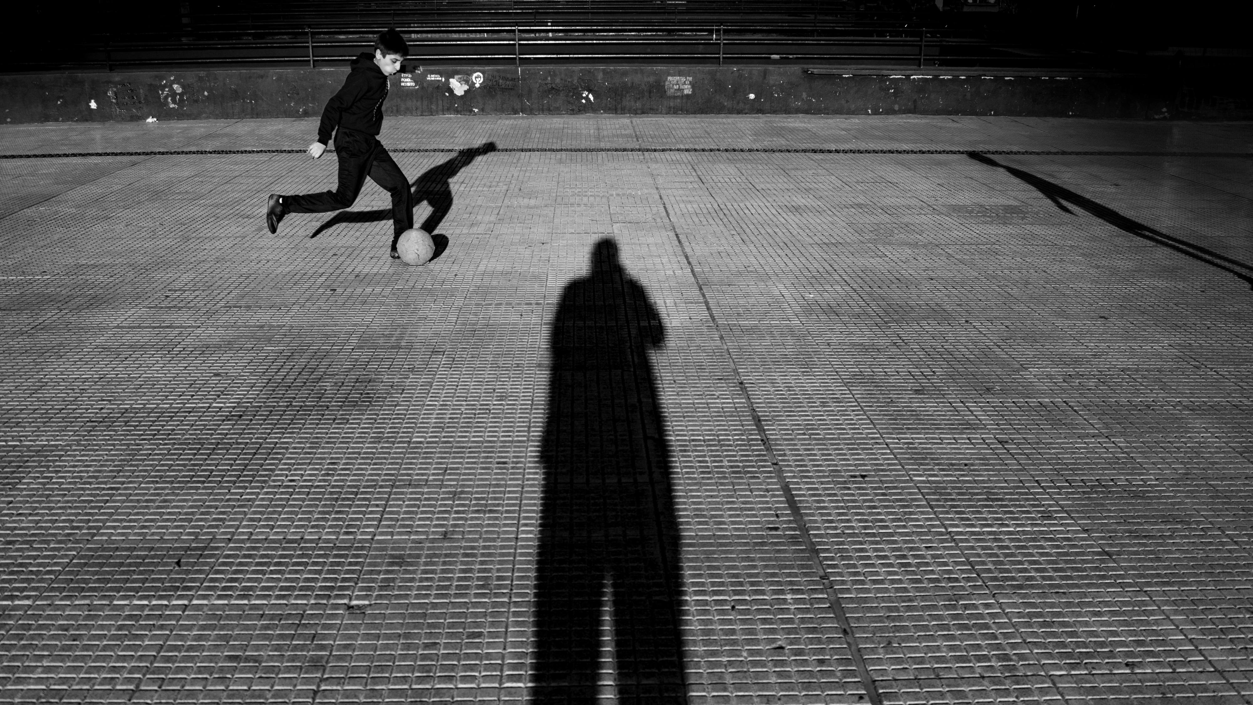 Boy Playing Soccer in Black and White · Free Stock Photo