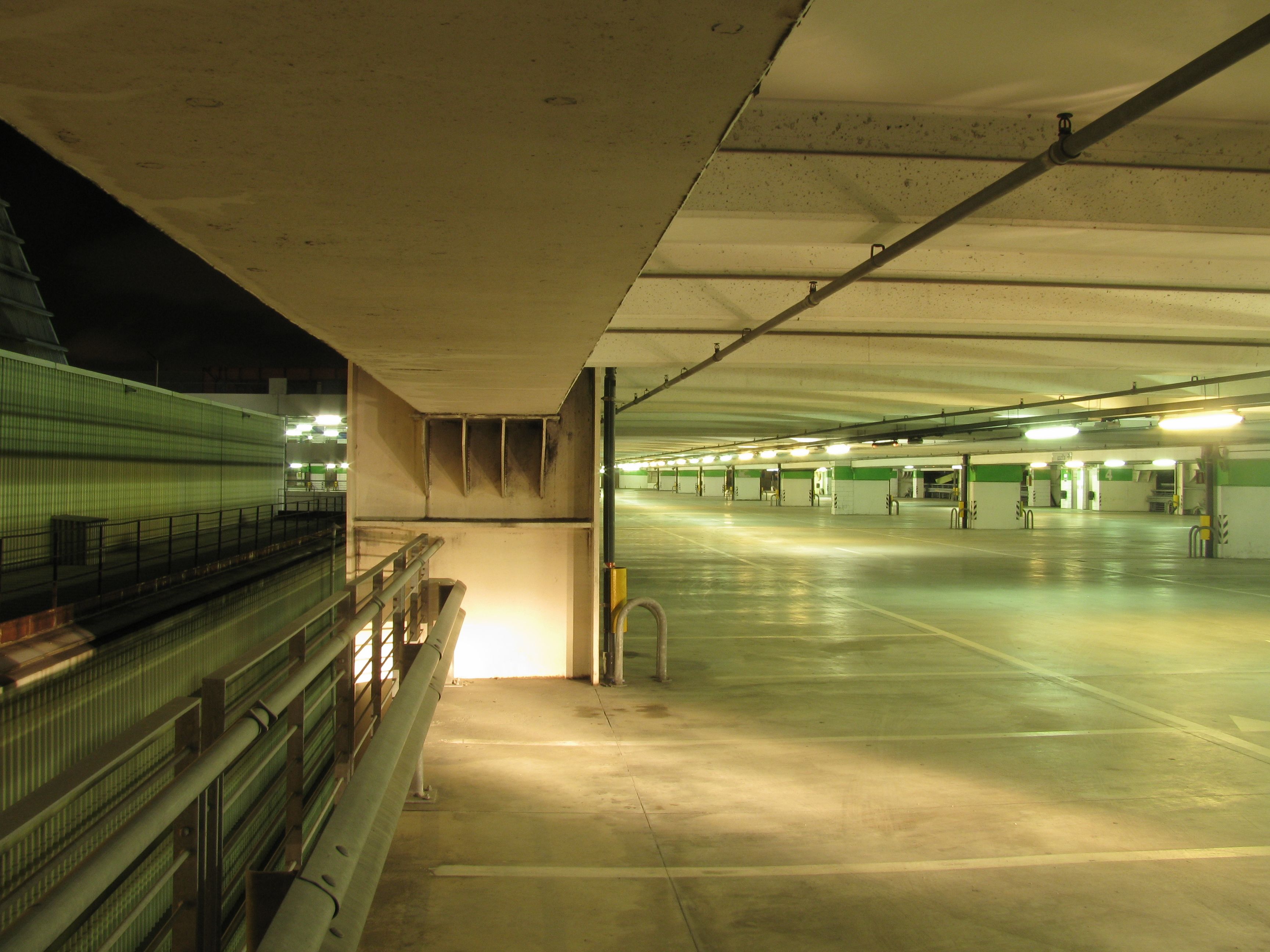 Illuminated Empty Floor of a Parking Garage at Night · Free Stock Photo