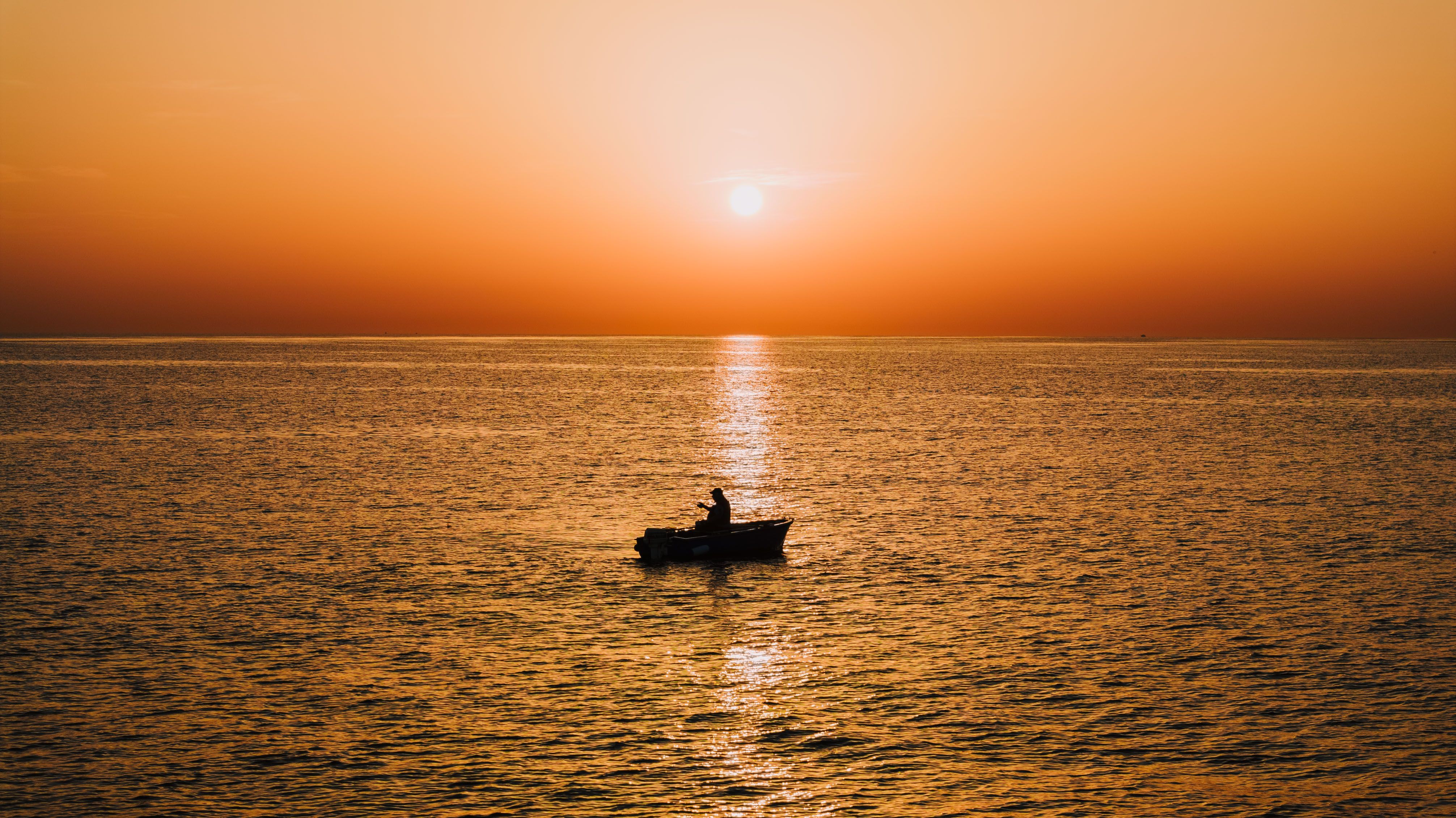 Fisherman on Boat During Sunset · Free Stock Photo