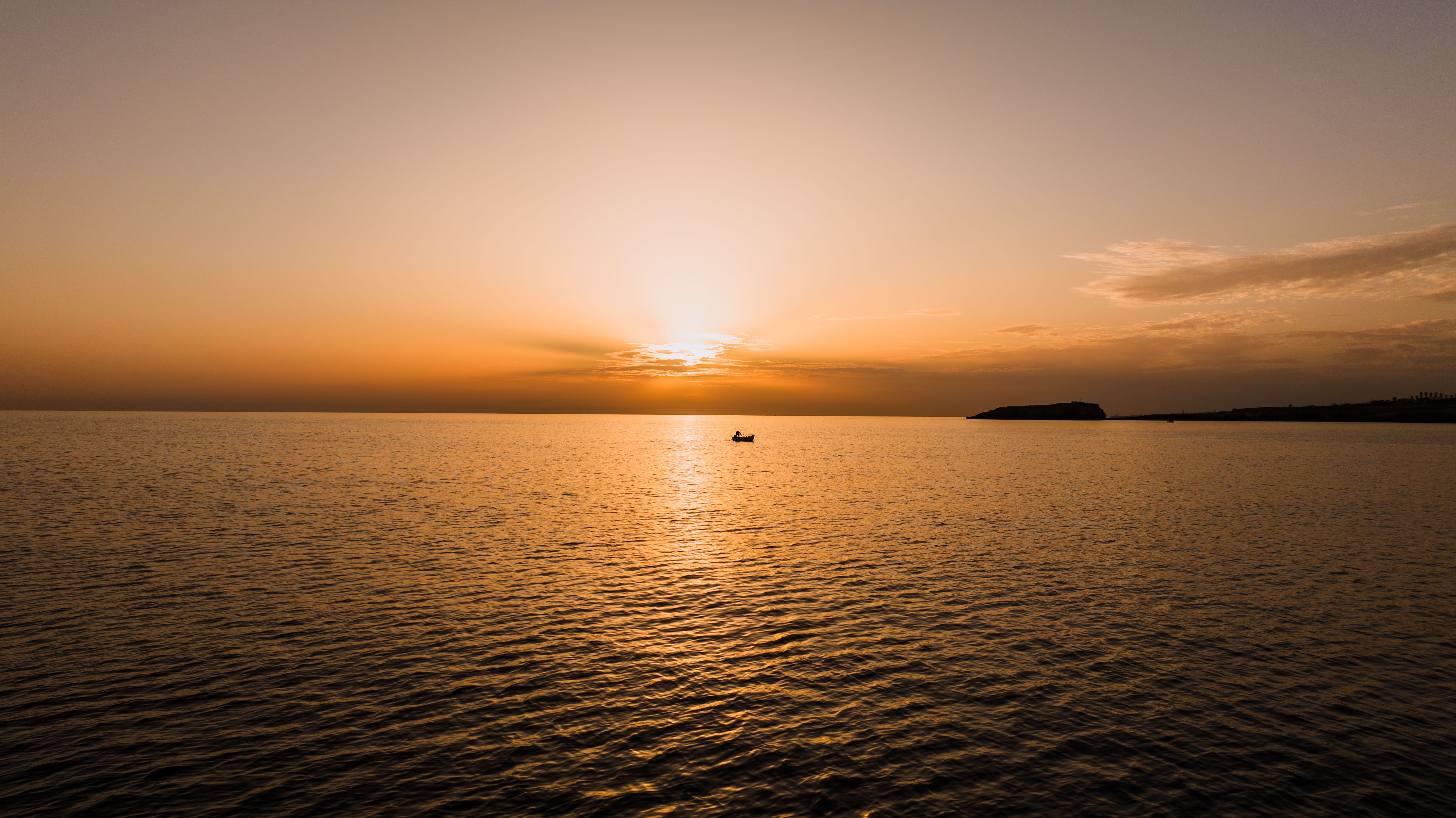 Person on Boat Alone on Ocean at Dusk · Free Stock Photo