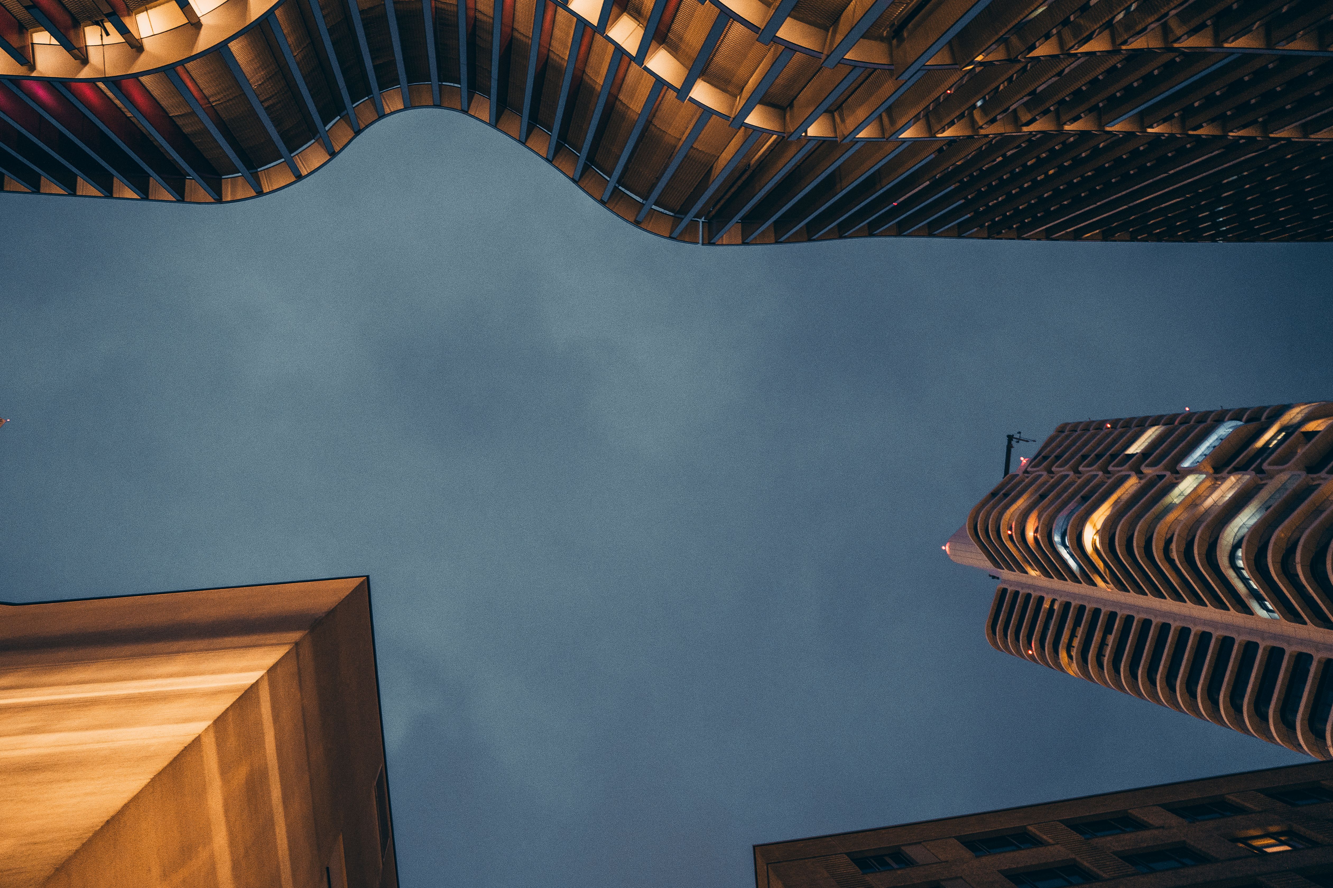 Modern Illuminated High-Rise Buildings Seen from below · Free Stock Photo