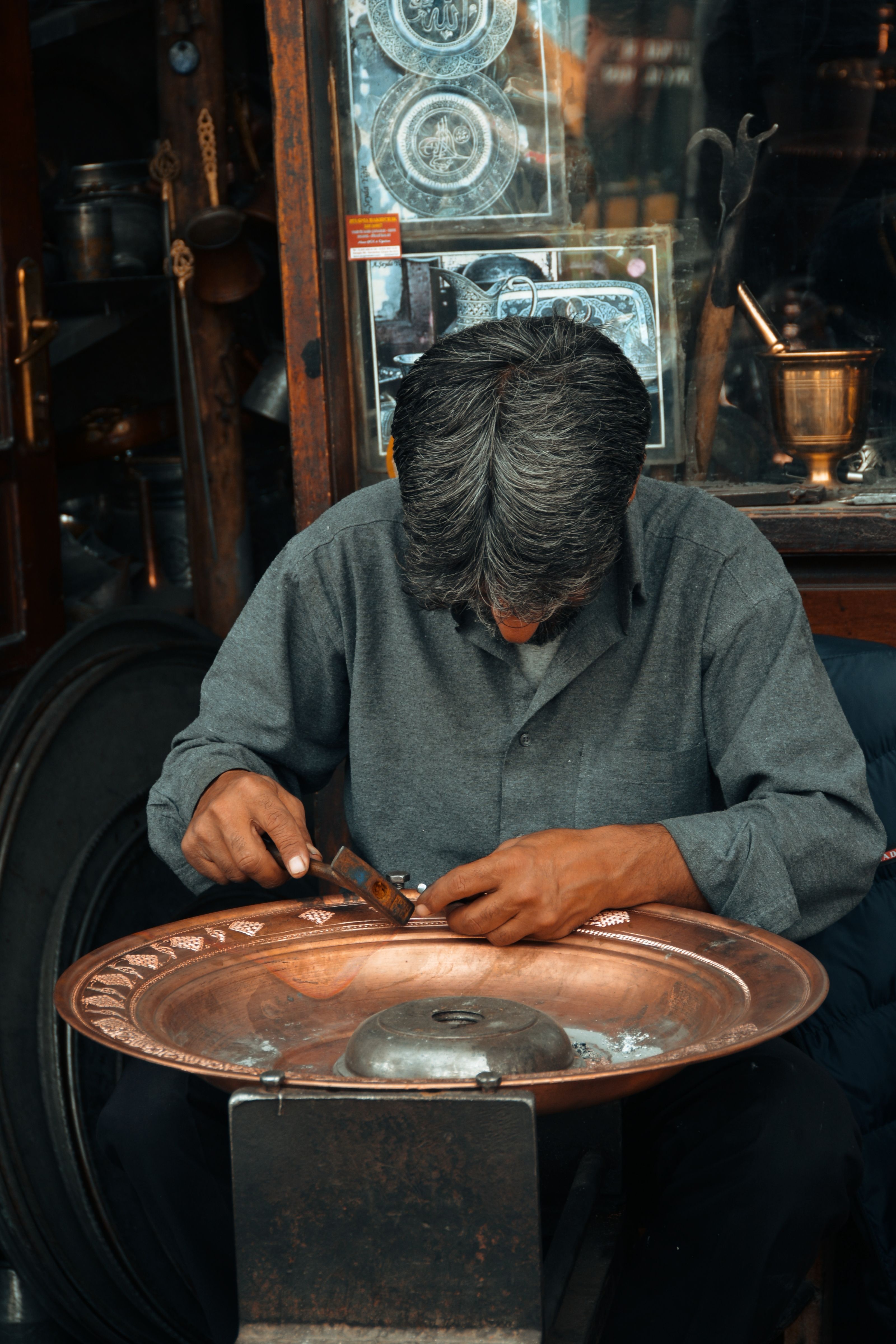 Craftsman Engraving Ornaments on a Brass Plate · Free Stock Photo
