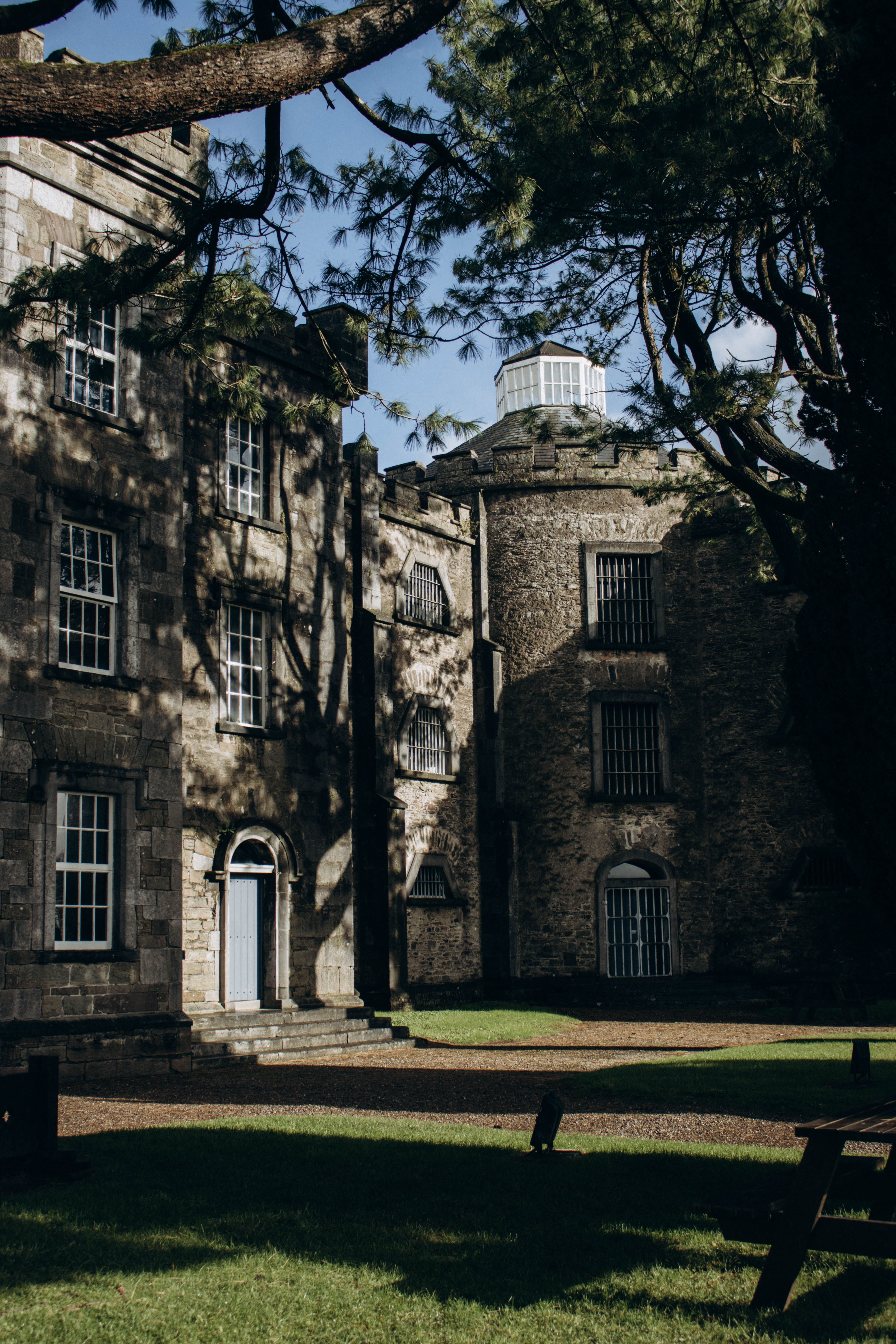 Facade of an Old Prison and Trees Casting Shadows · Free Stock Photo