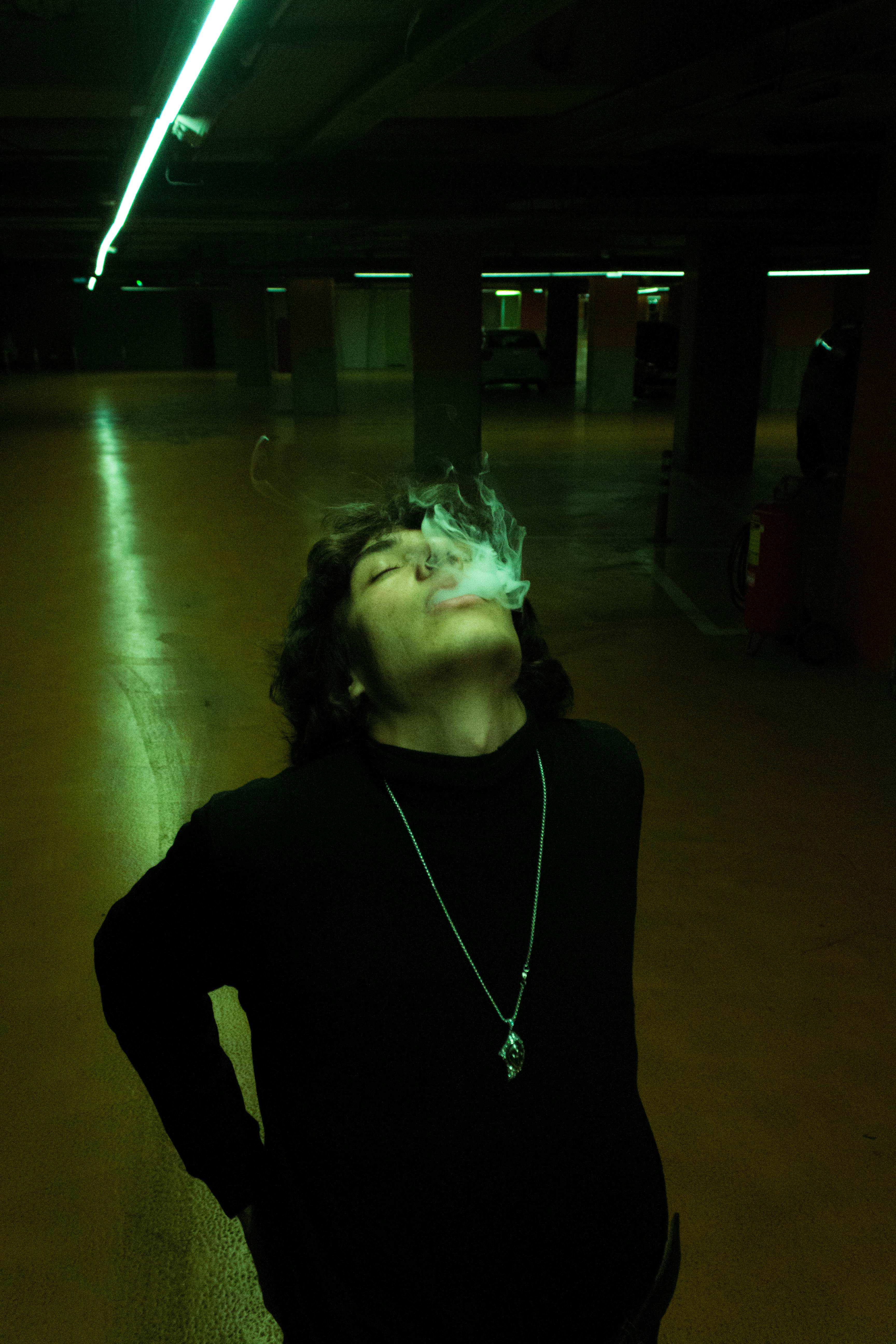 A Young Man Puffing Smoke · Free Stock Photo