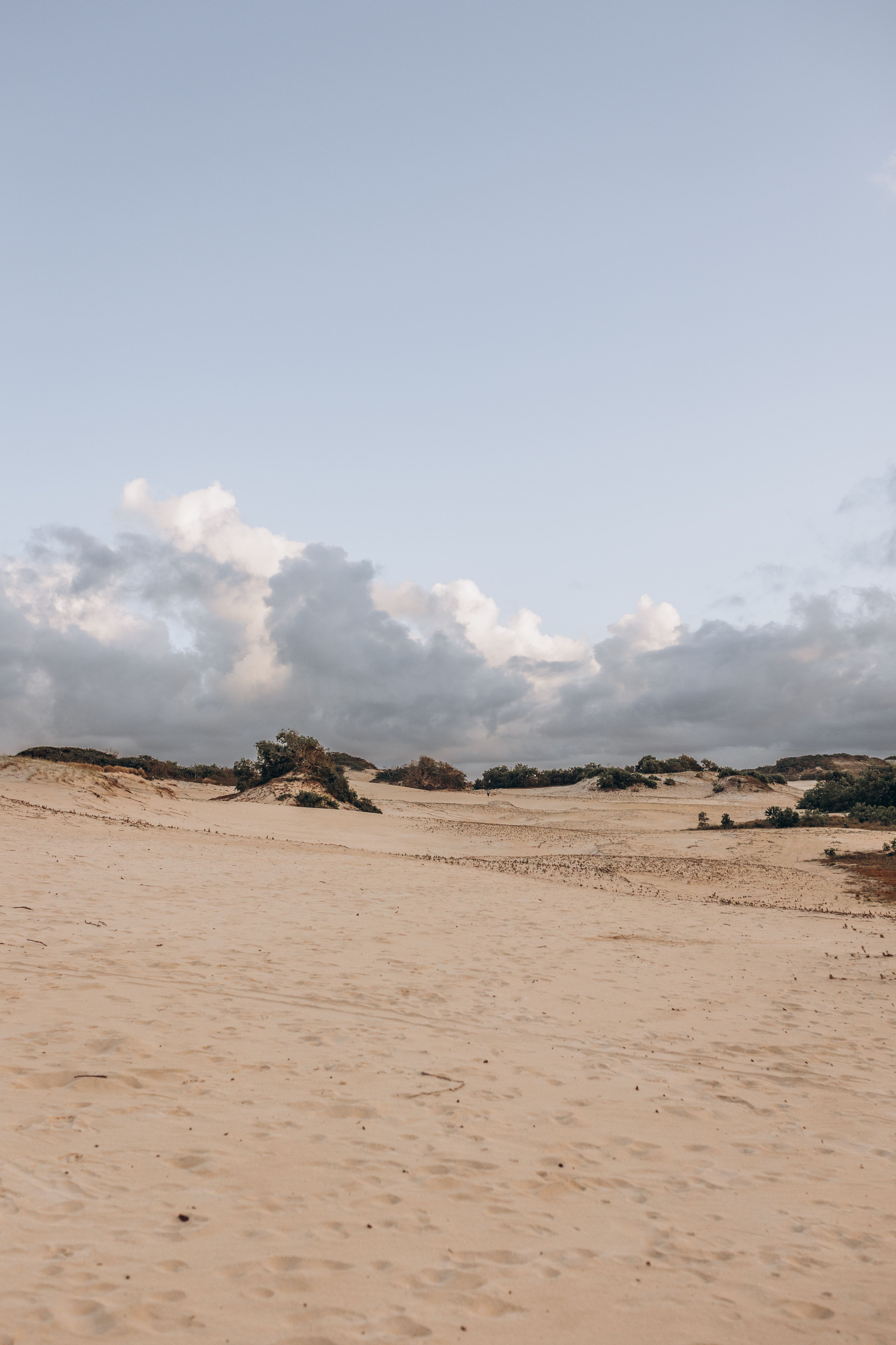 Fluffy Clouds over Sandy Desert · Free Stock Photo