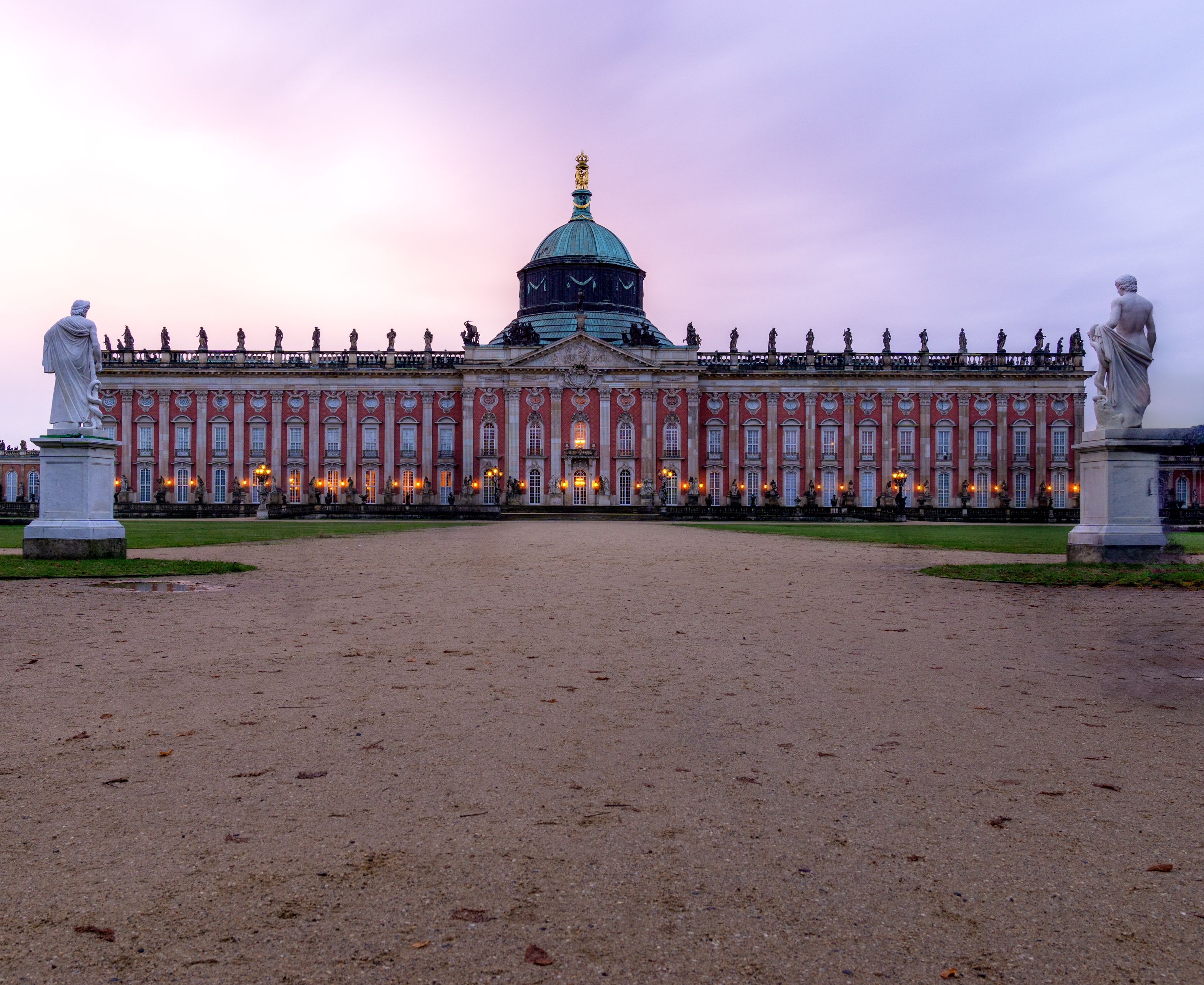 A large palace with statues in front of it · Free Stock Photo