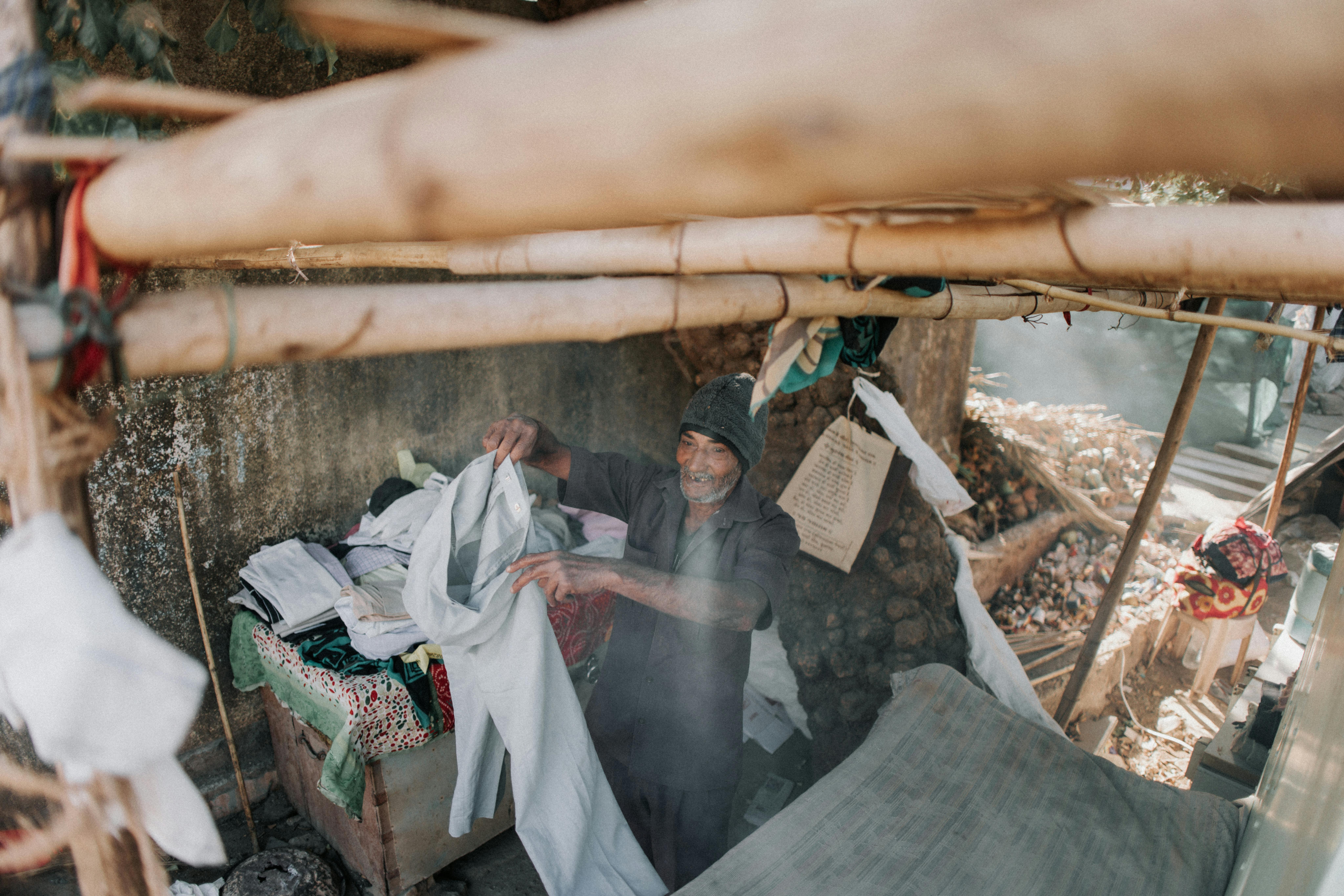 Toothless Man Holding Shirt · Free Stock Photo