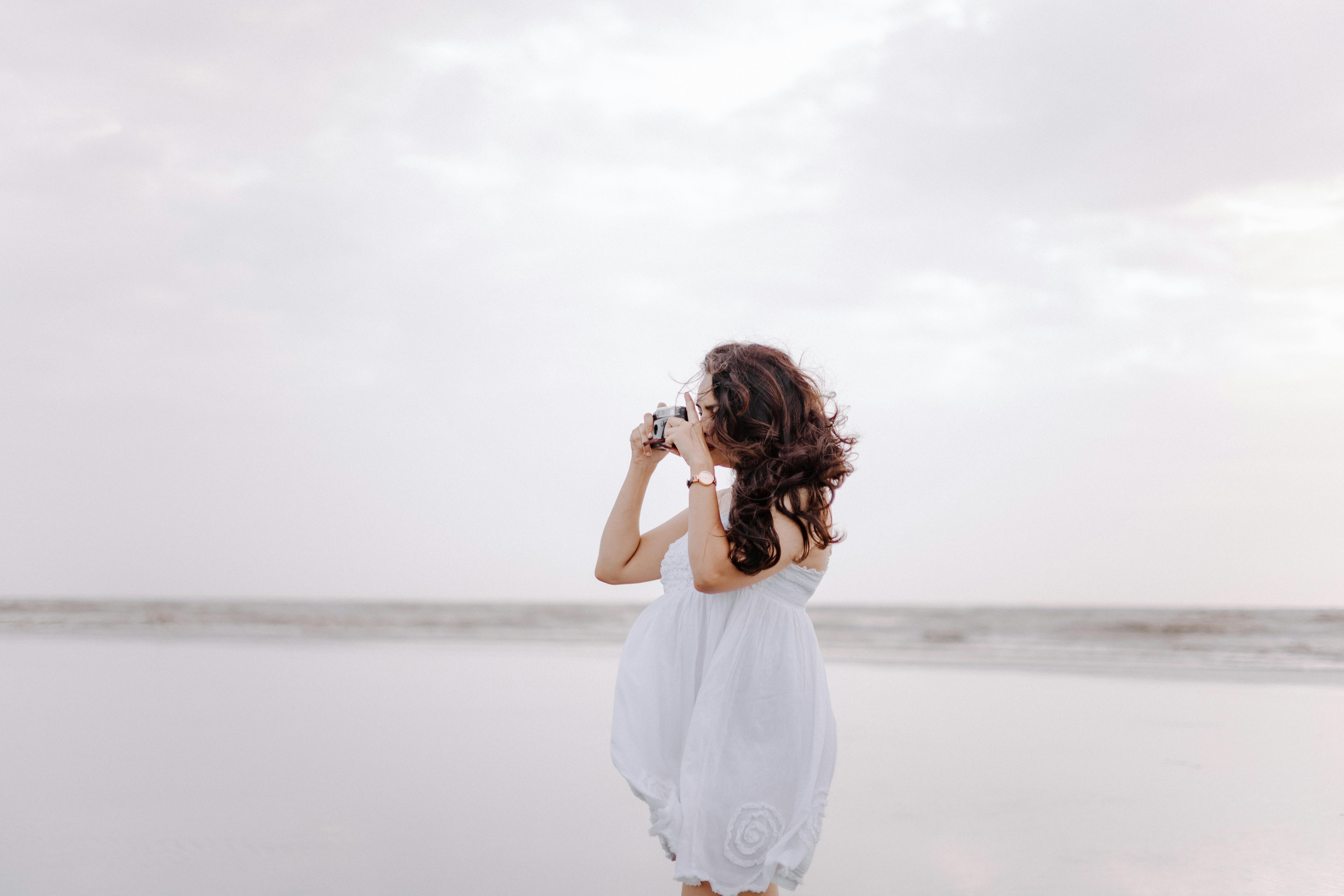 Woman Posing in Green Dress on a Beach · Free Stock Photo