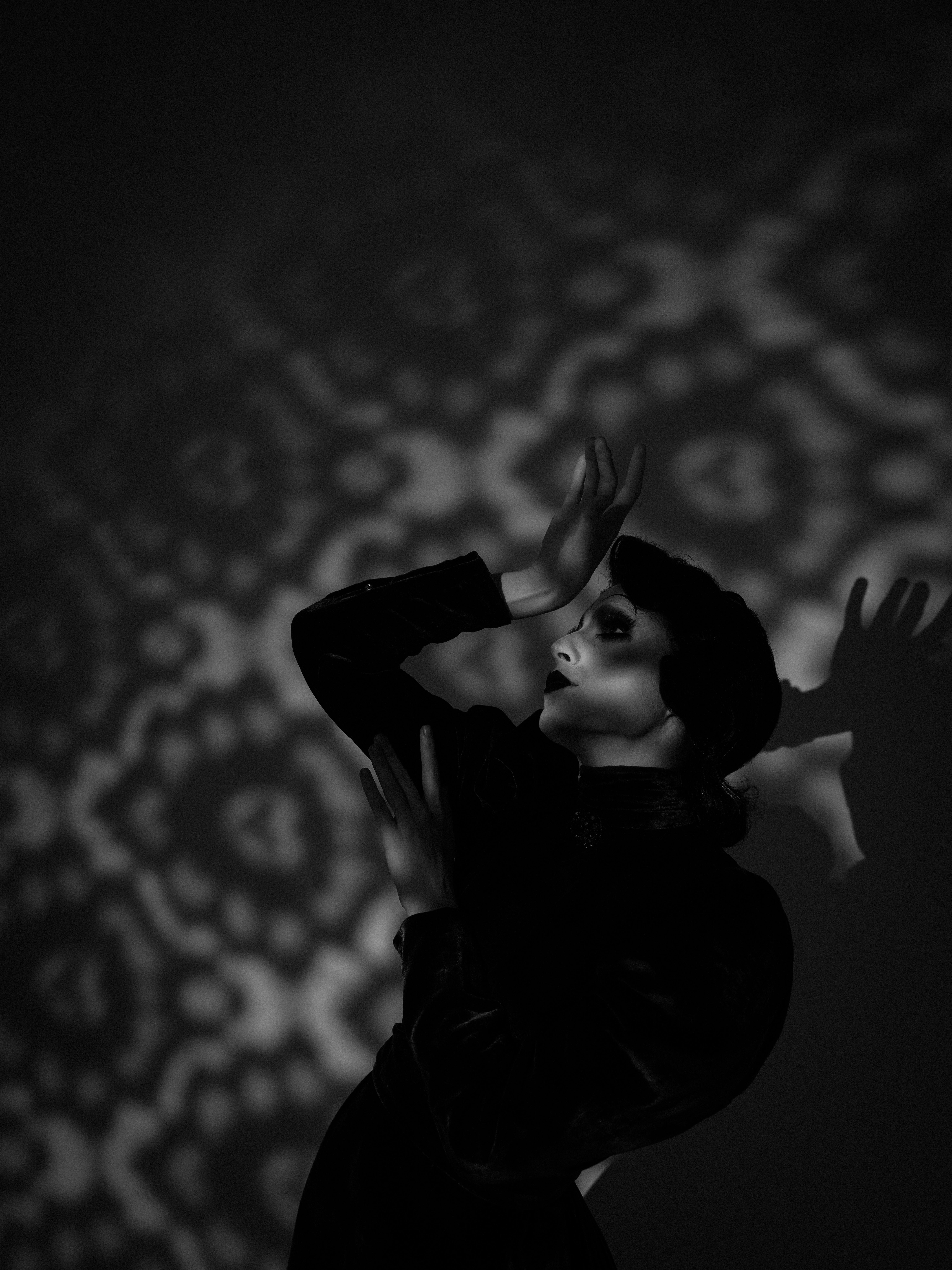 Black and White Photo of a Woman Posing in the Shadows · Free Stock Photo