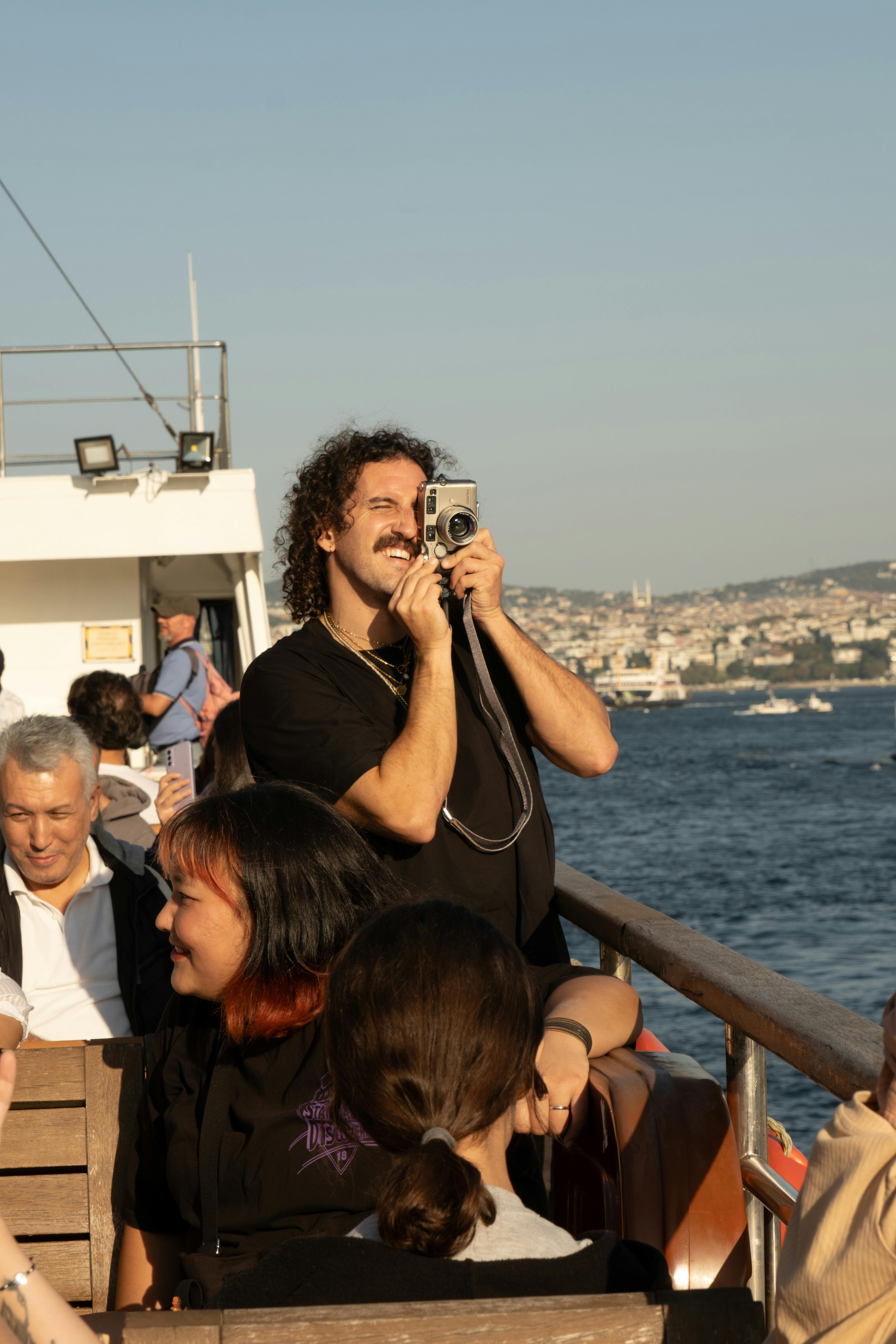Man with Long Hair Sailing on Bosphorus in Istanbul and Taking Pictures ...