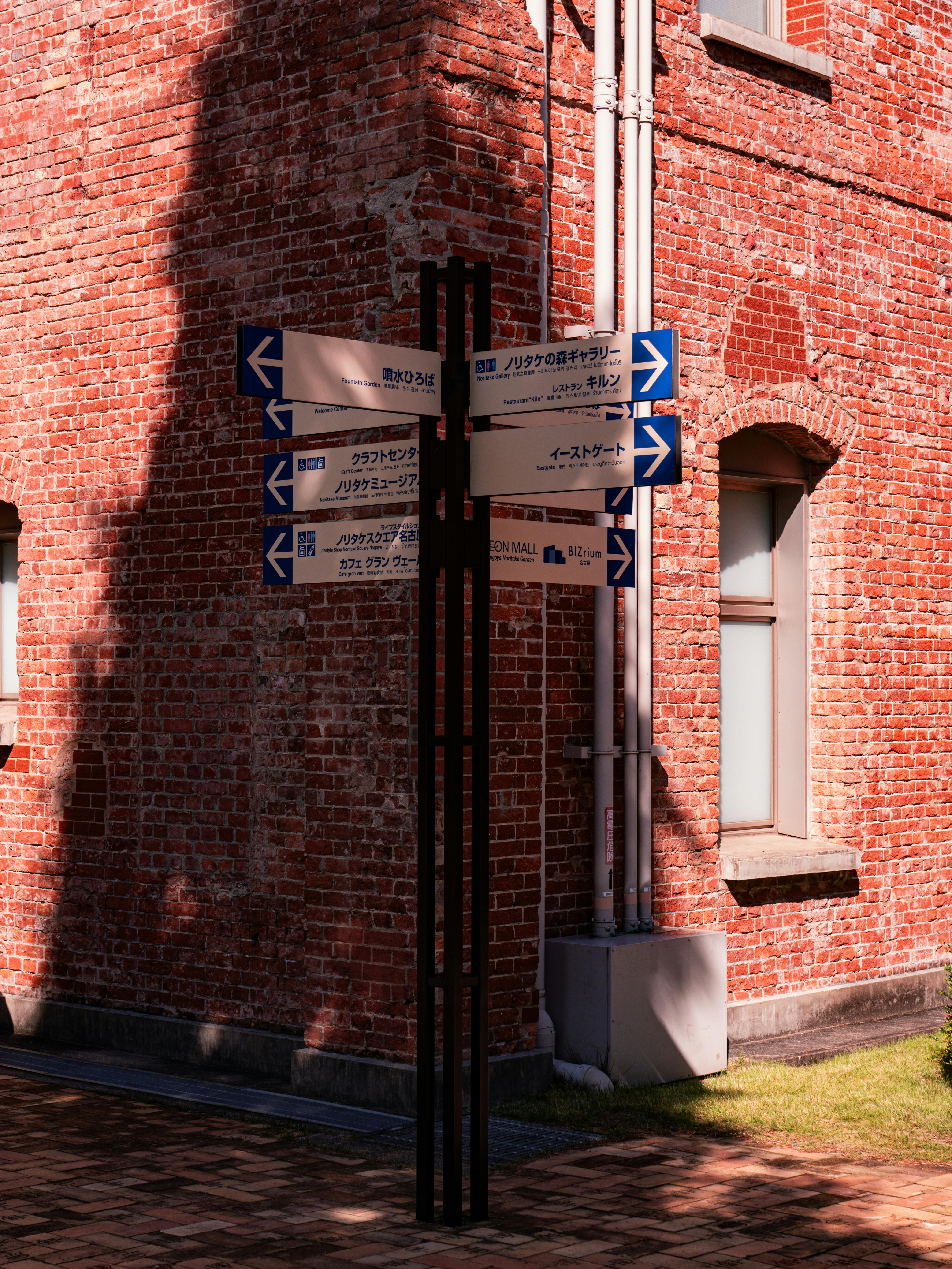 Directional Signs in Vintage Building Corner · Free Stock Photo