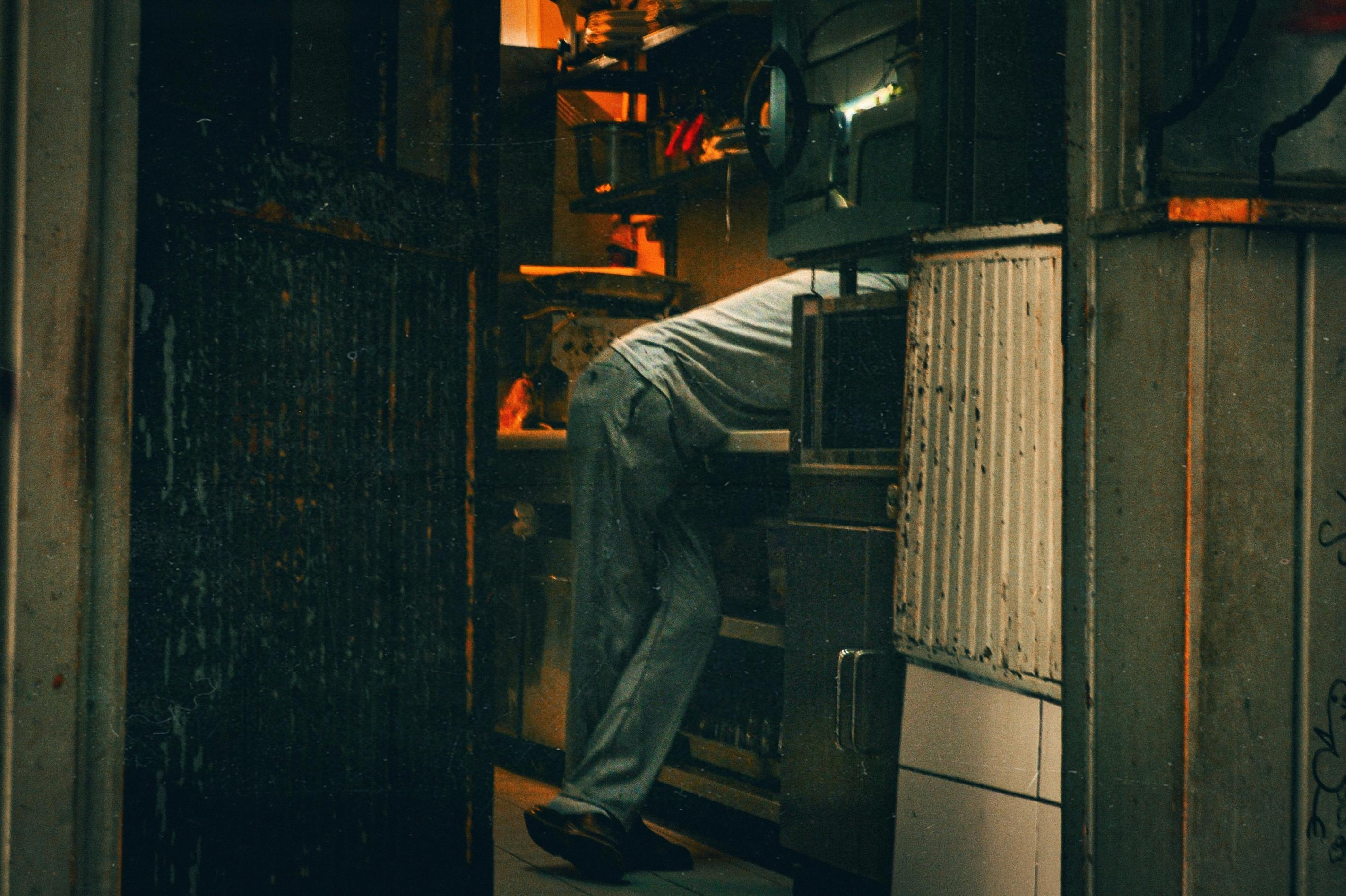 Man Leaning on Counter in Kitchen · Free Stock Photo