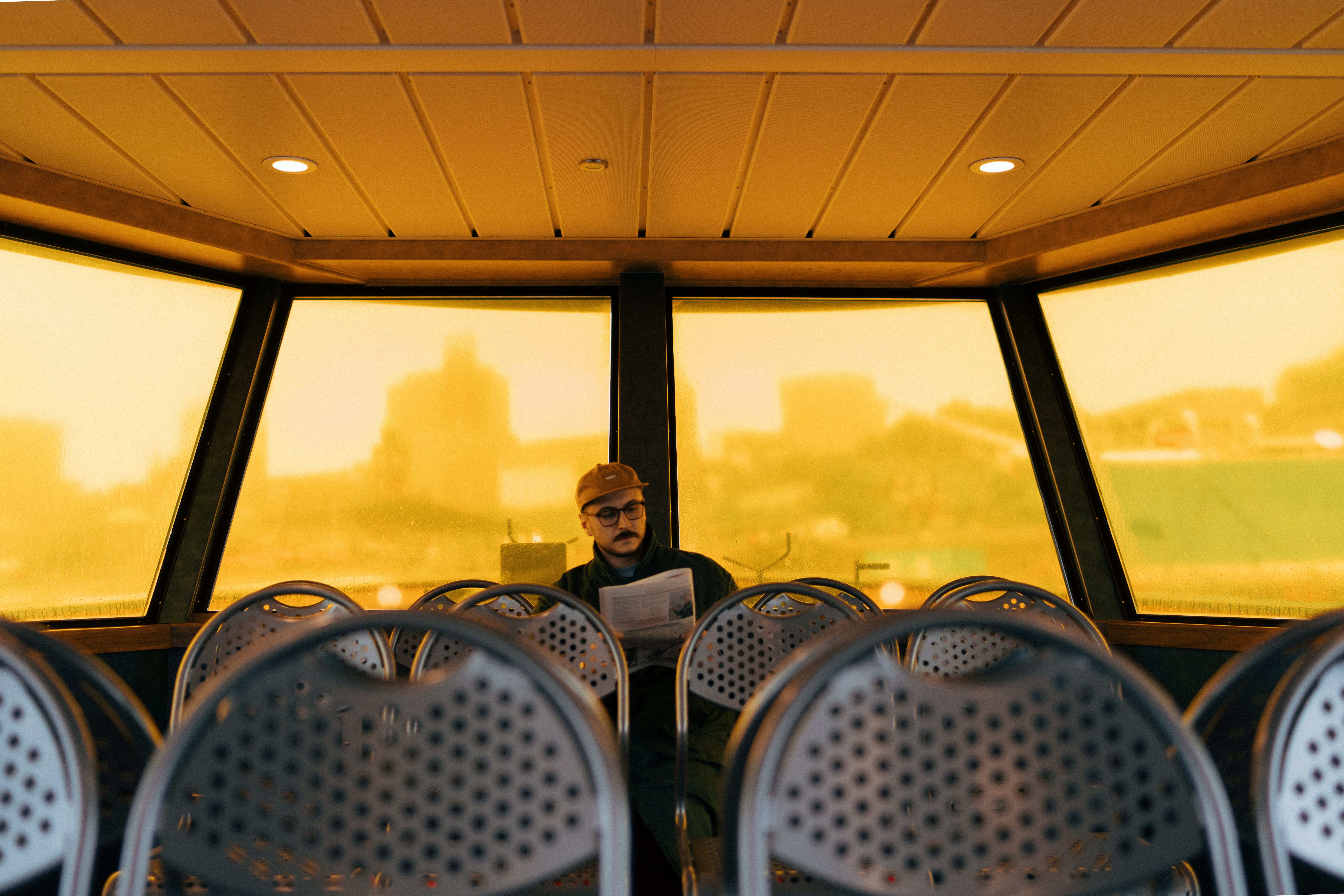 Brunette Woman in Dress Reading Newspaper on Ferry · Free Stock Photo