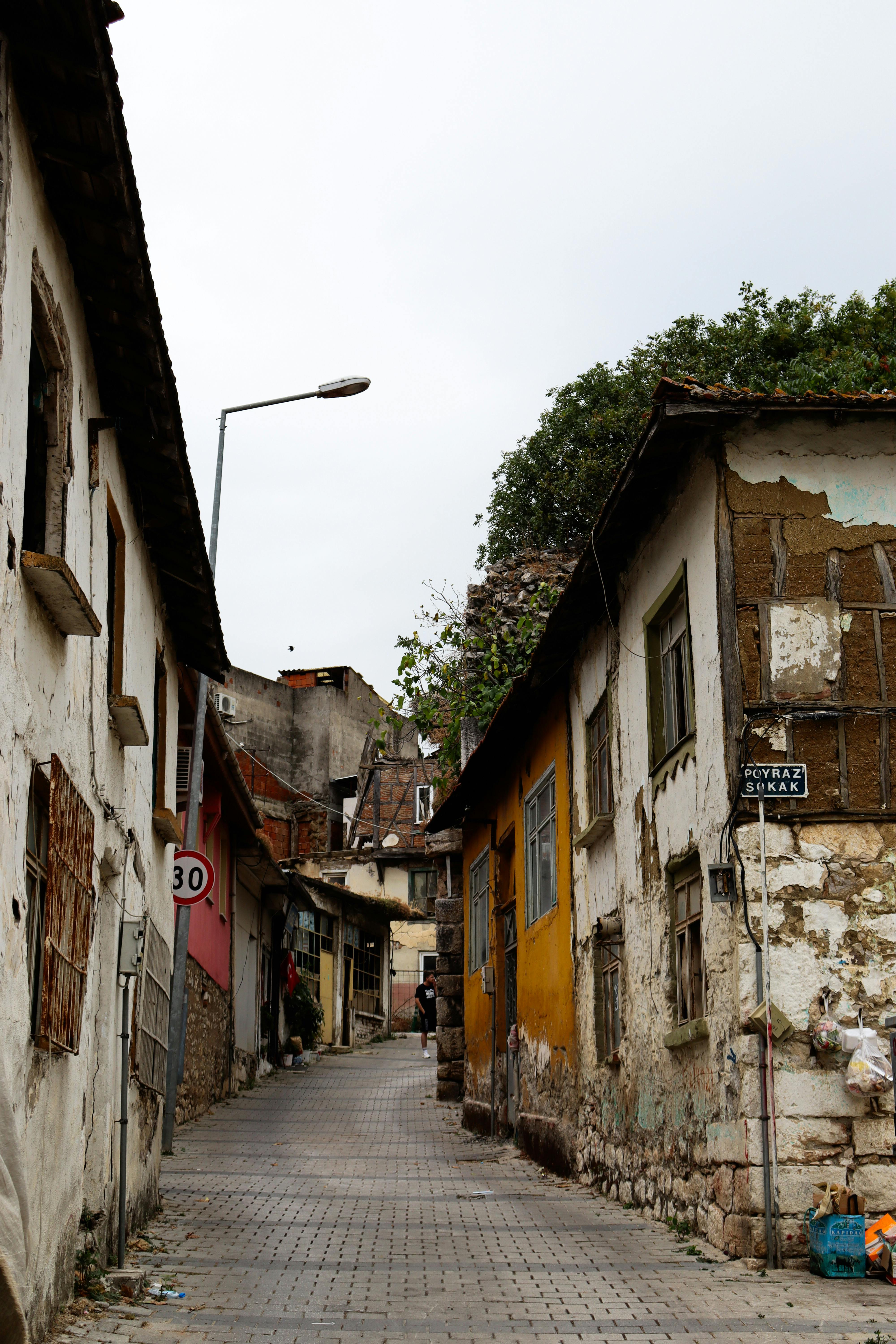 Decrepit House by Paving Street · Free Stock Photo
