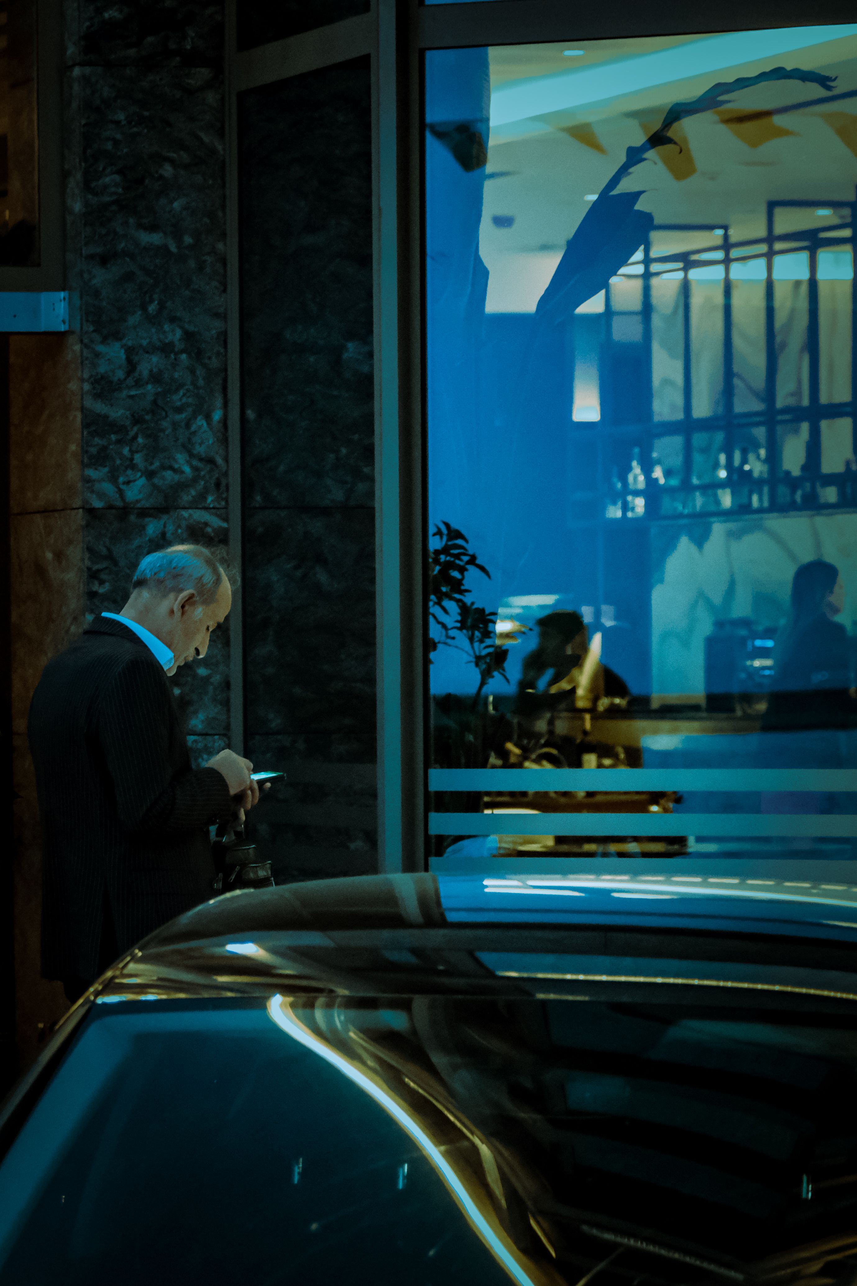 Elegant Man in Front of Hotel at Night · Free Stock Photo