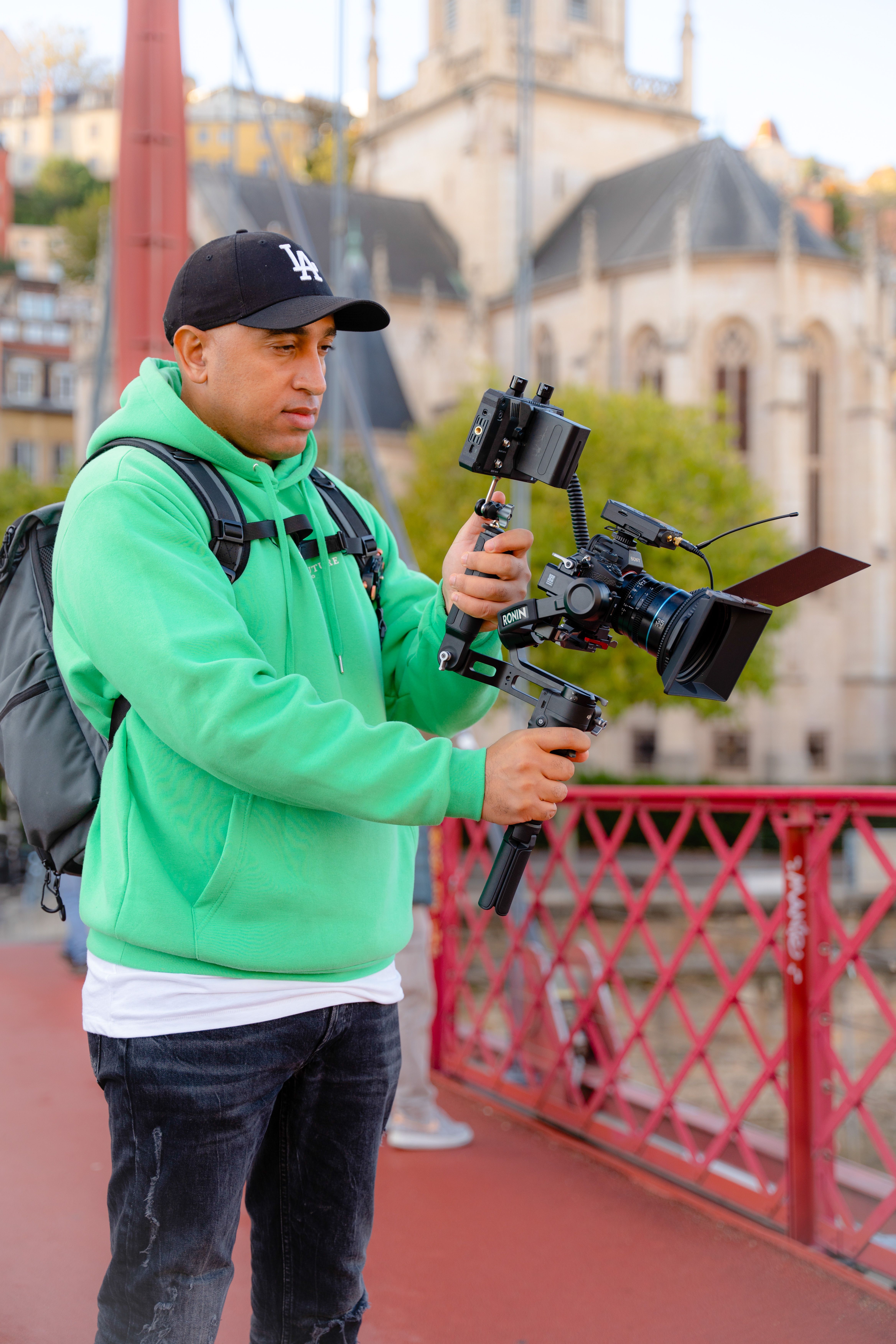 Man with Professional Camera Filming in City · Free Stock Photo
